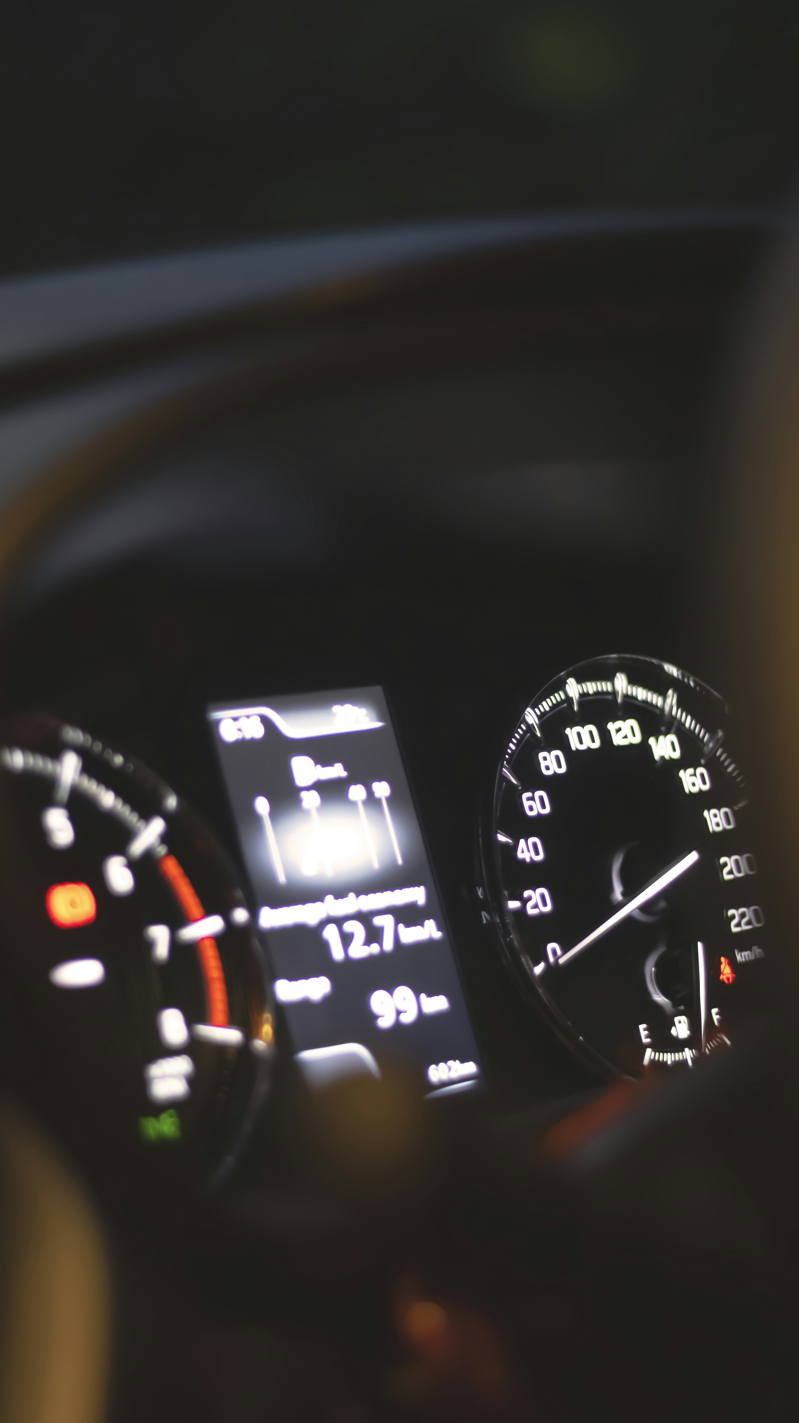A car dashboard with a speedometer and other gauges photo – Free ...