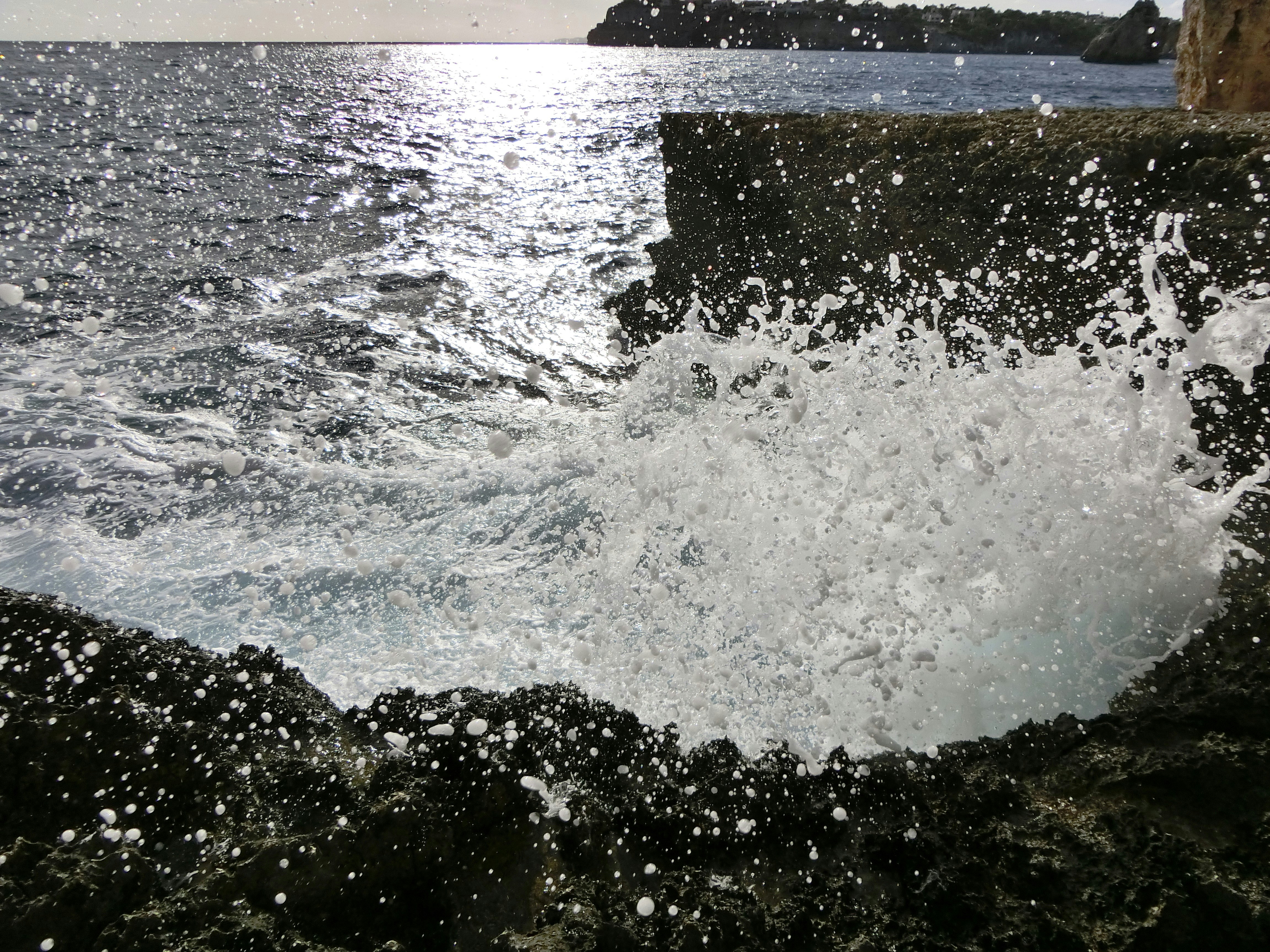 Sunlit Sea Spray Catapults Over a Rugged Breakwater