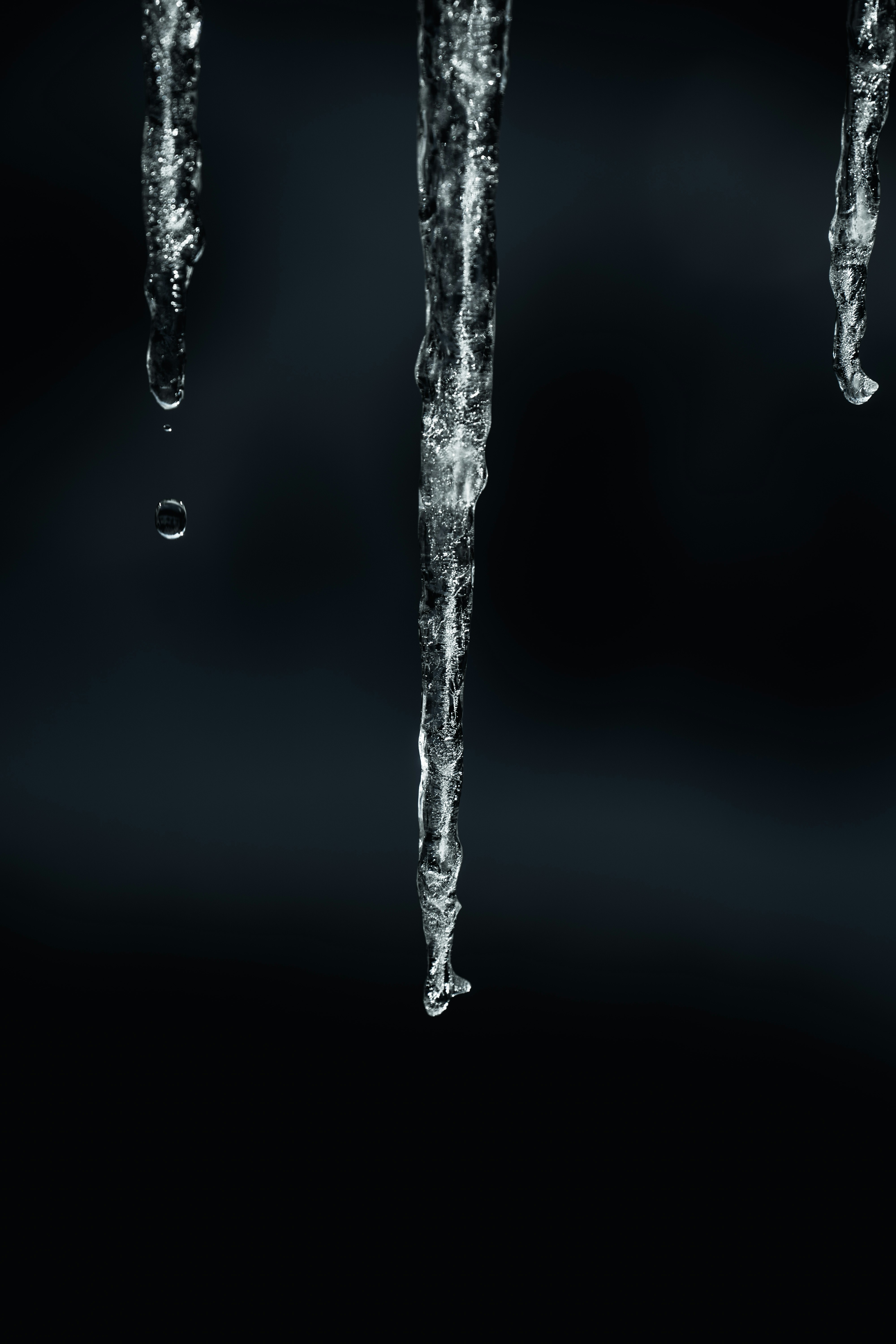Midnight Crystal Drip: Macro Study of Icicles and a Droplet