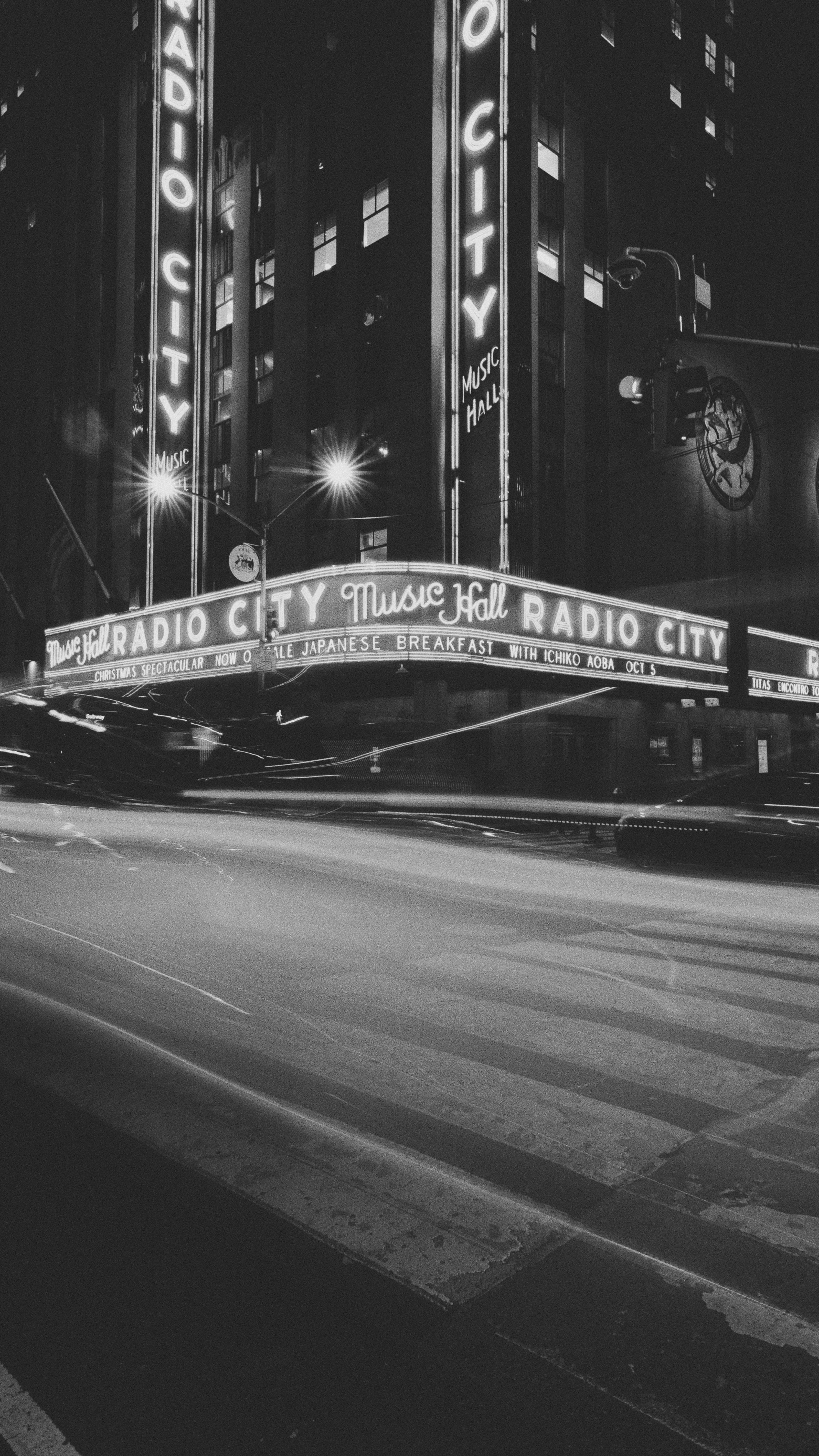 Neon Nights: Theater Marquee Echoes Over Quiet Street
