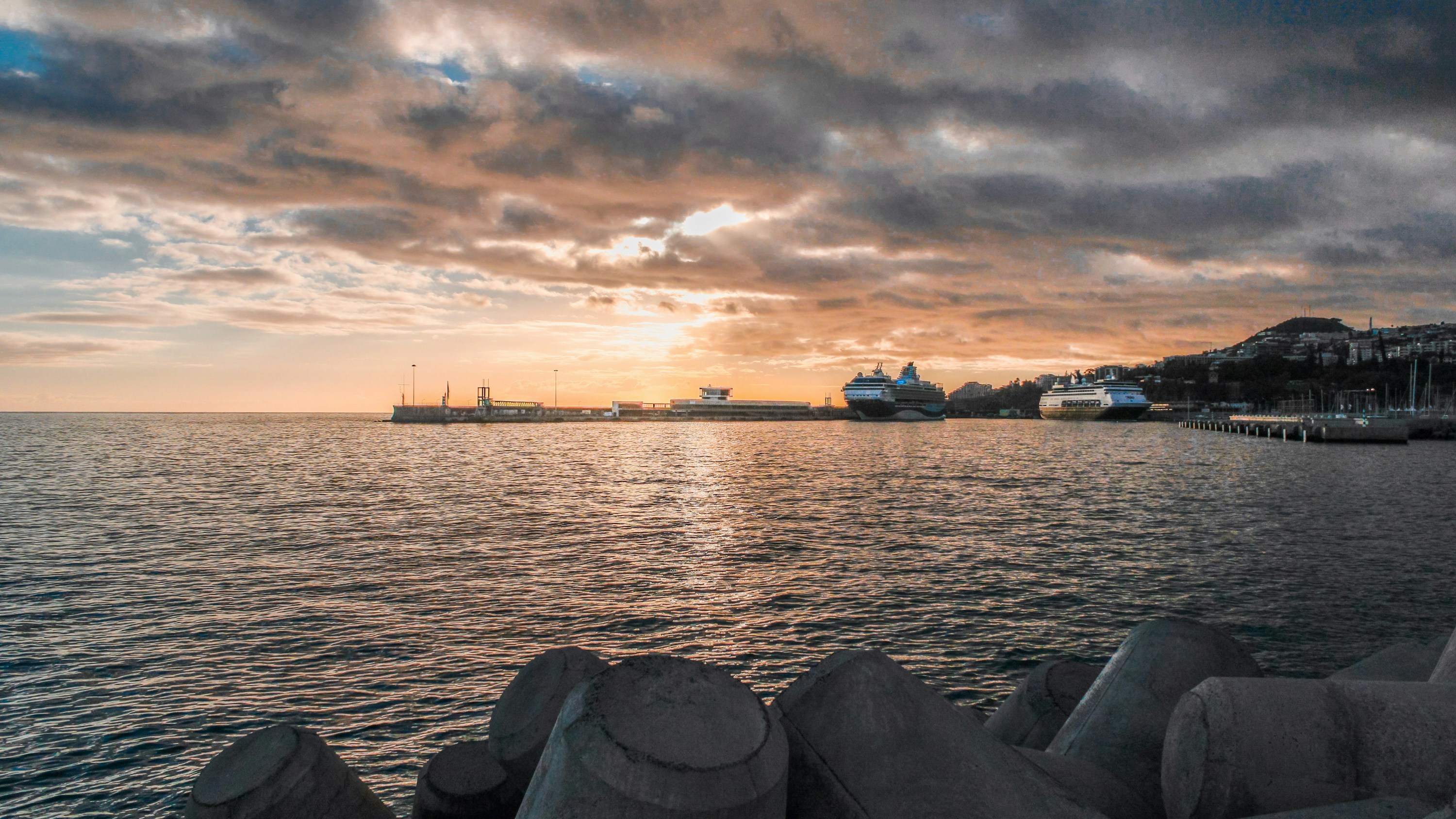 A view of a body of water at sunset photo – Free Cais do funchal Image ...