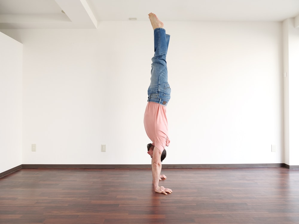 Une personne faisant le poirier sur un plancher en bois photo – Photo L ... Une personne faisant le poirier sur un plancher en bois photo – Photo L ...
