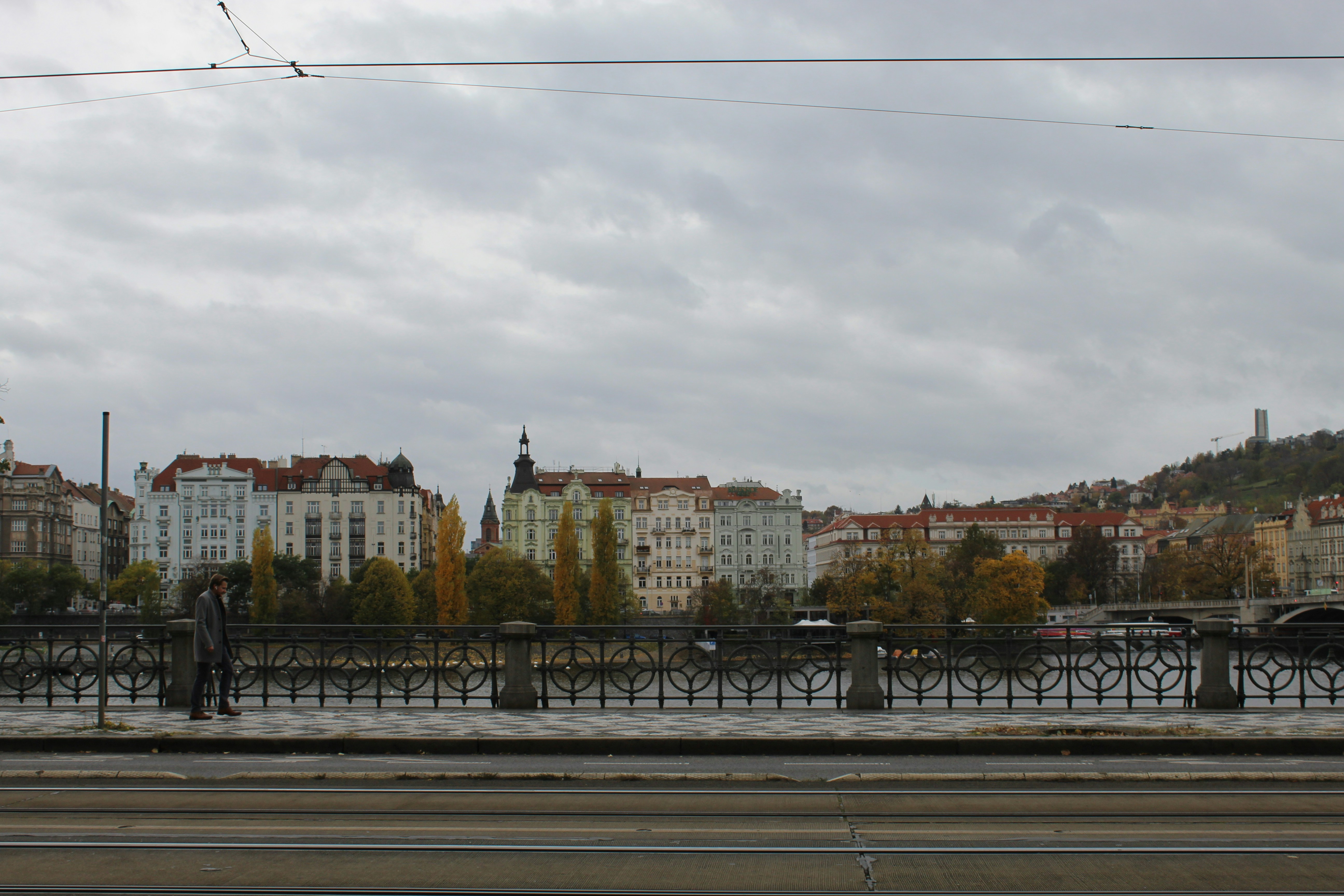 Riverside Palette: Colorful facades along the river under a moody sky