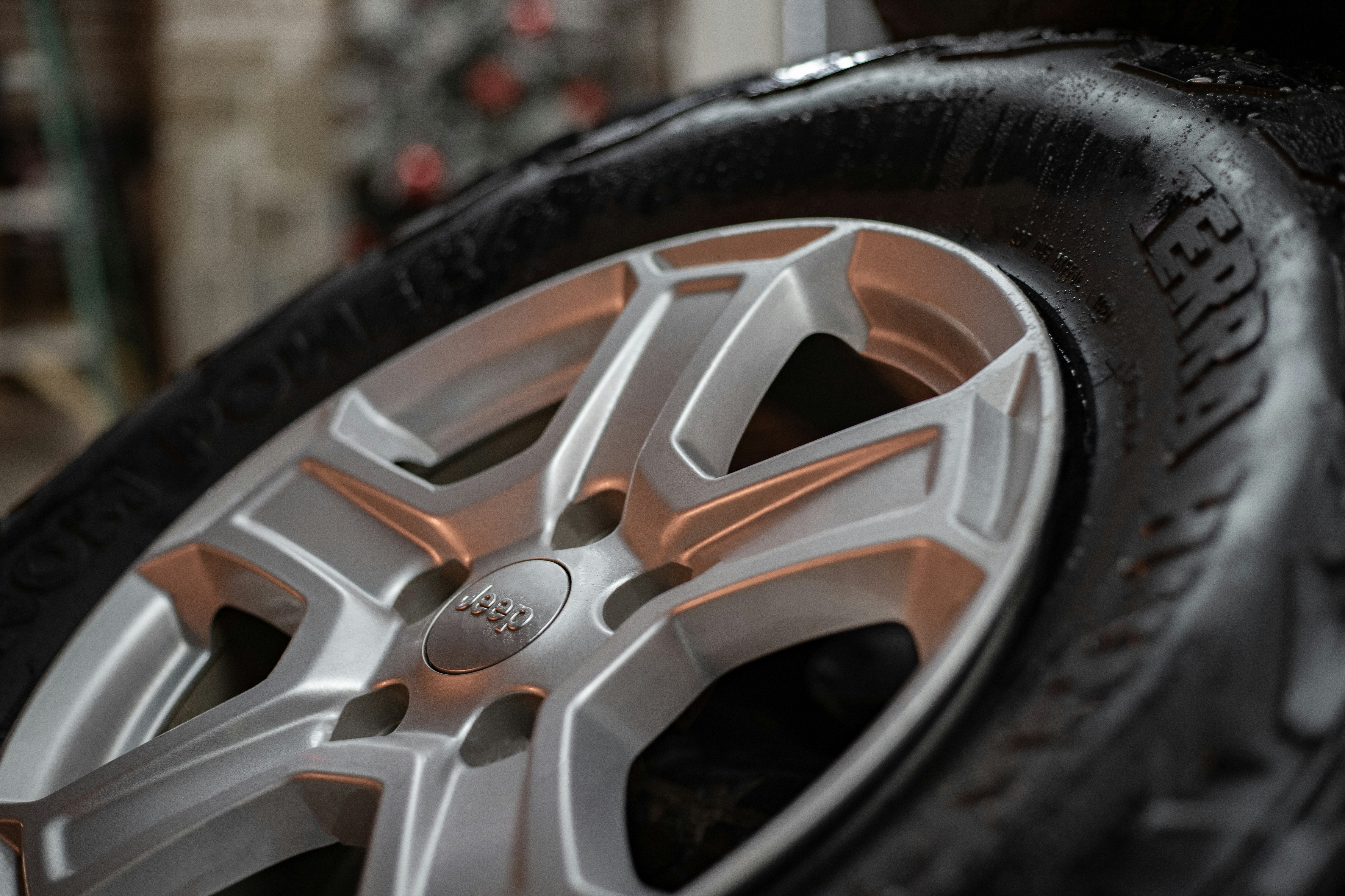 Rain-Kissed Alloy: Close-Up on a Car Wheel's Metallic Spokes