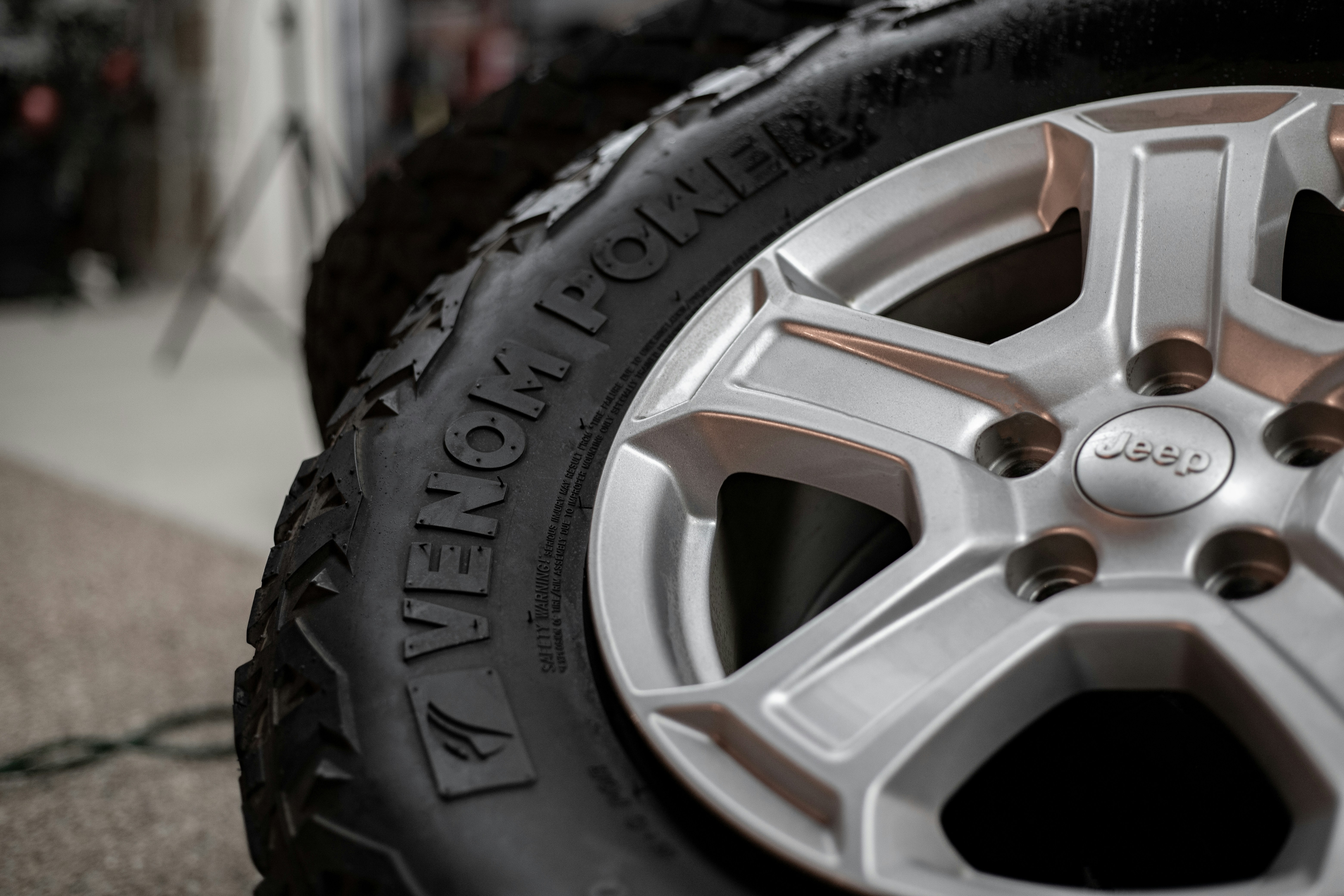 Rugged Precision: Close-Up of Jeep Alloy Wheel and All-Terrain Tire