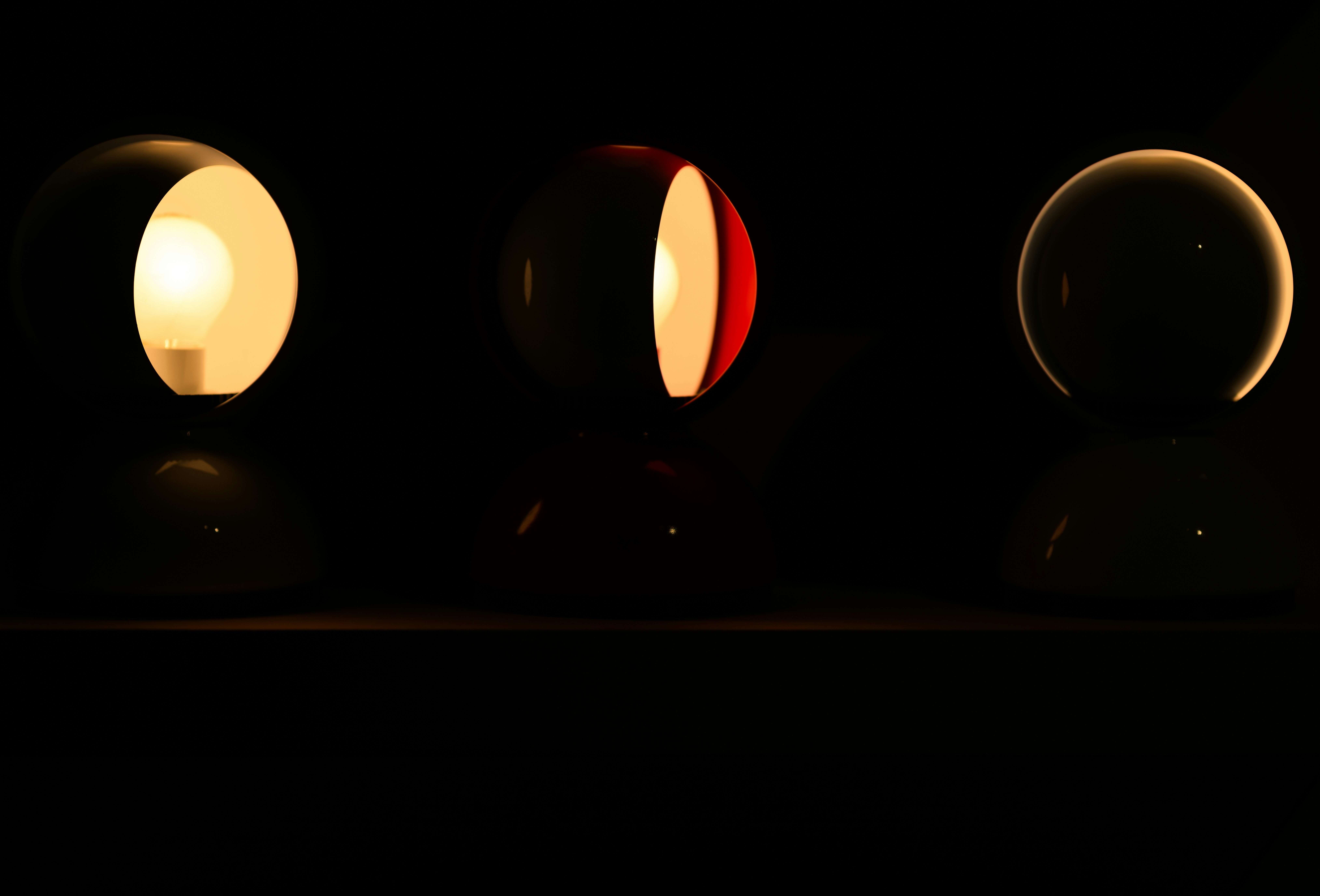 Triad of Orbs: Warm Glow, Crimson Core, and Silent Gloss