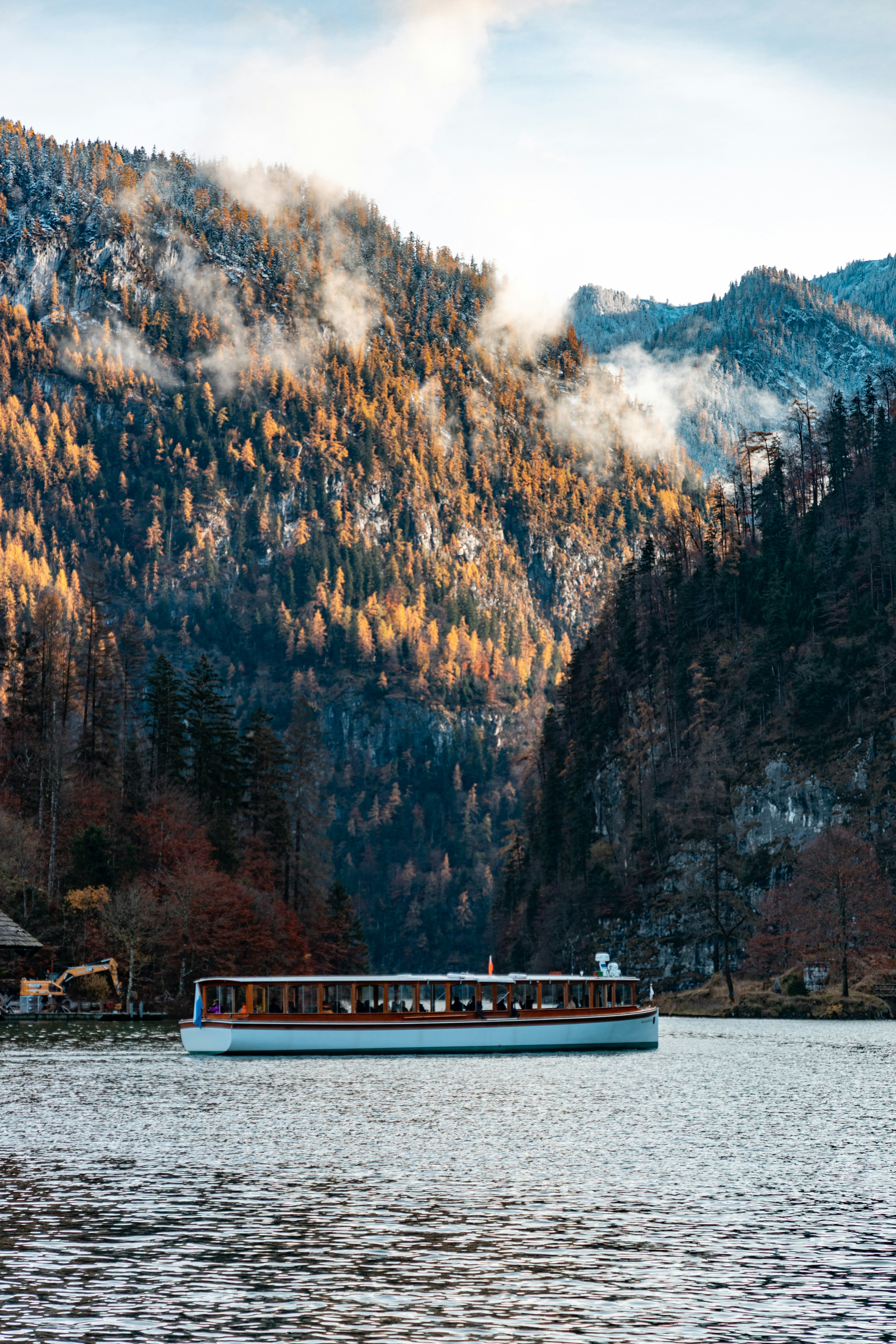Autumn Mist over the Alpine Lake: A Quiet Boat