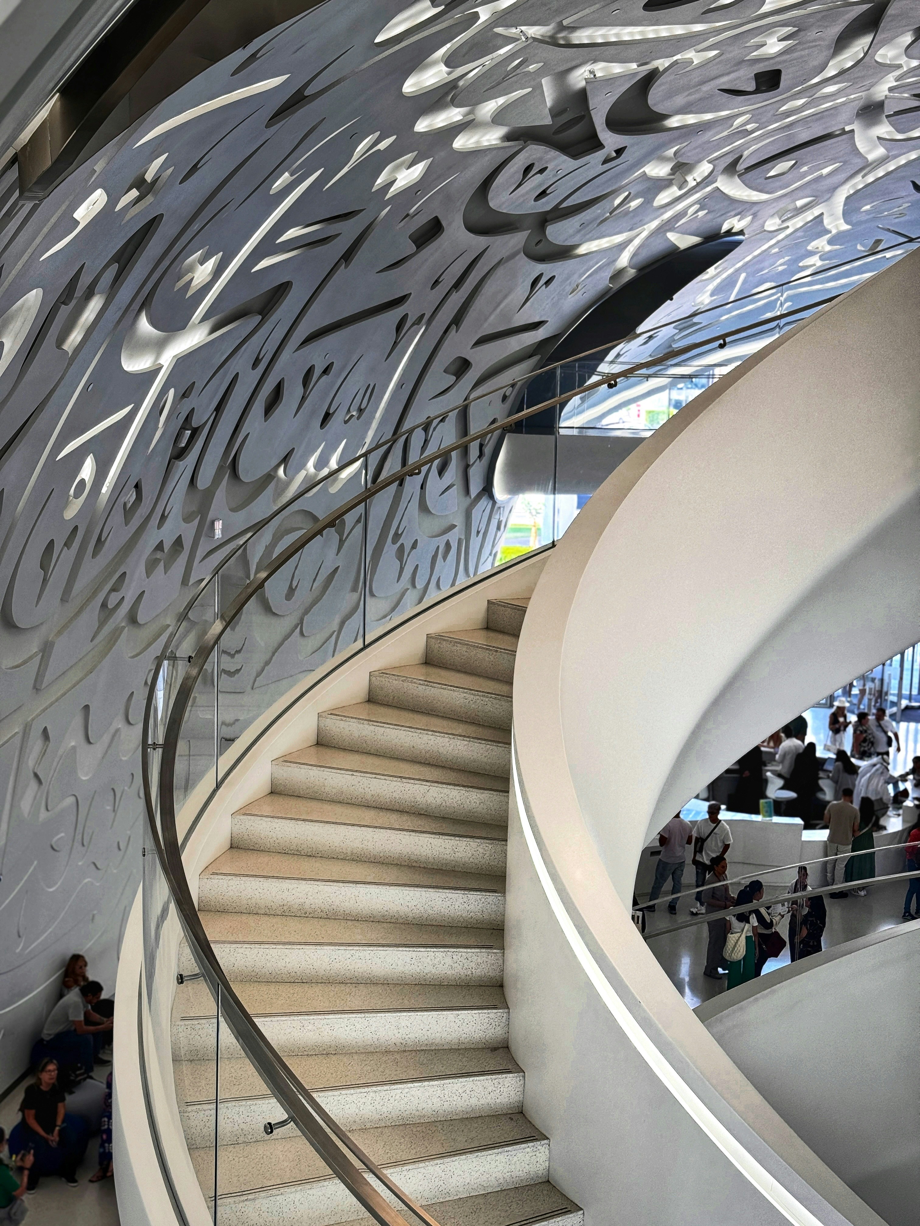 Spiral ascent through a sculpted gallery wall