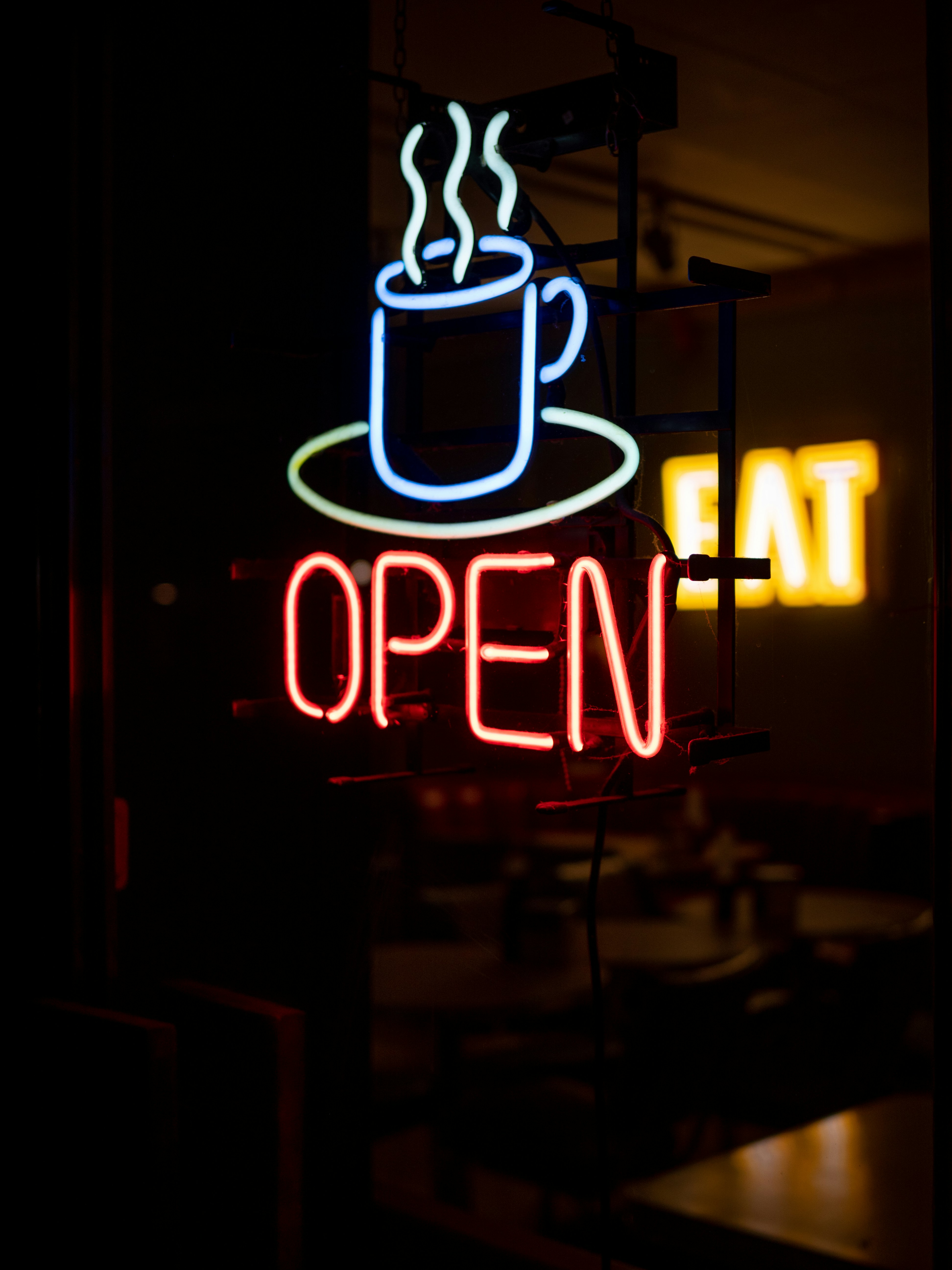 Neon Open: A Nighttime Café Sign Through Glass