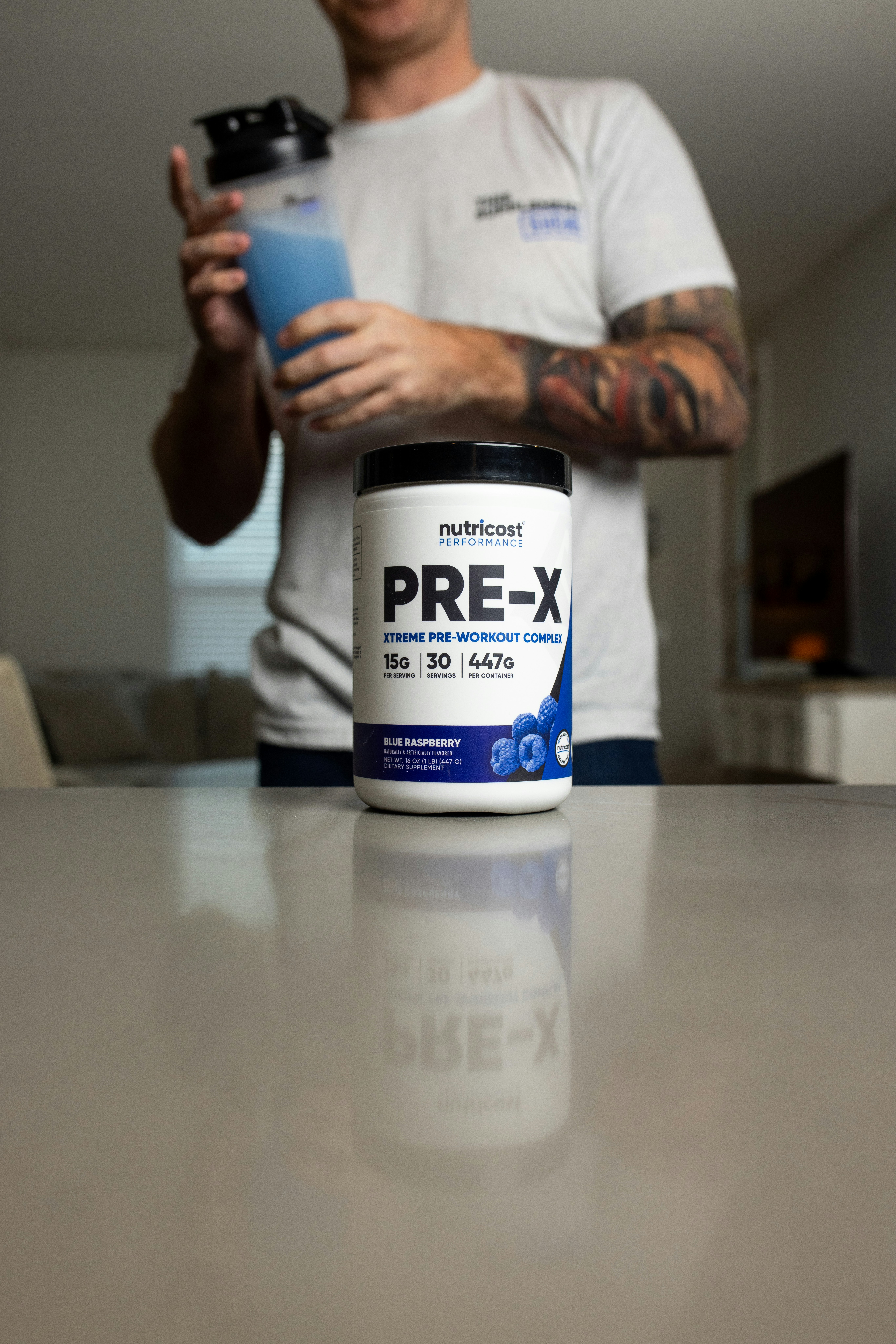 Blue Raspberry Power: Focus on the Protein Jar in a Home Gym Scene