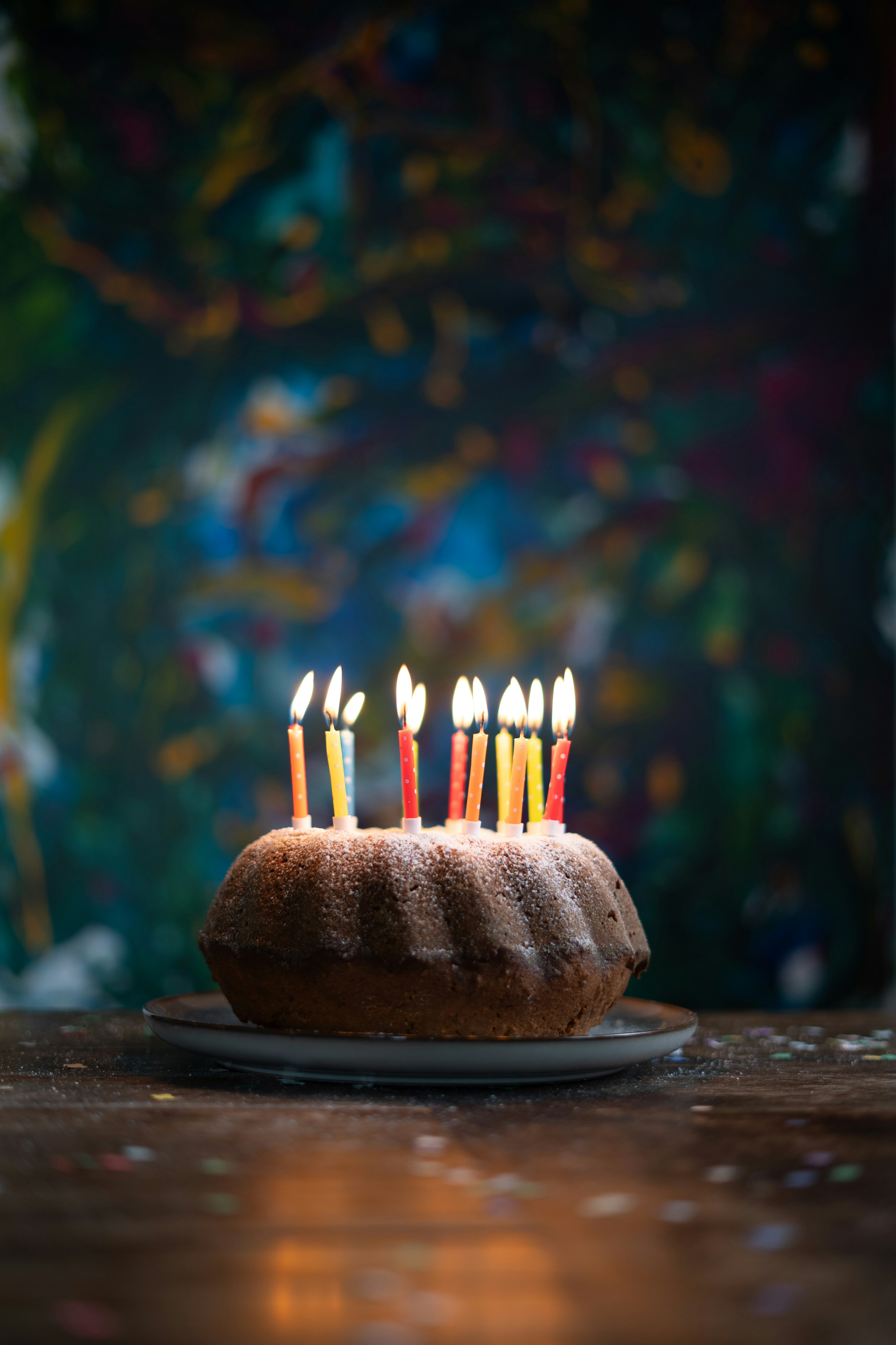 A birthday cake with lit candles sitting on a table photo – Free ...