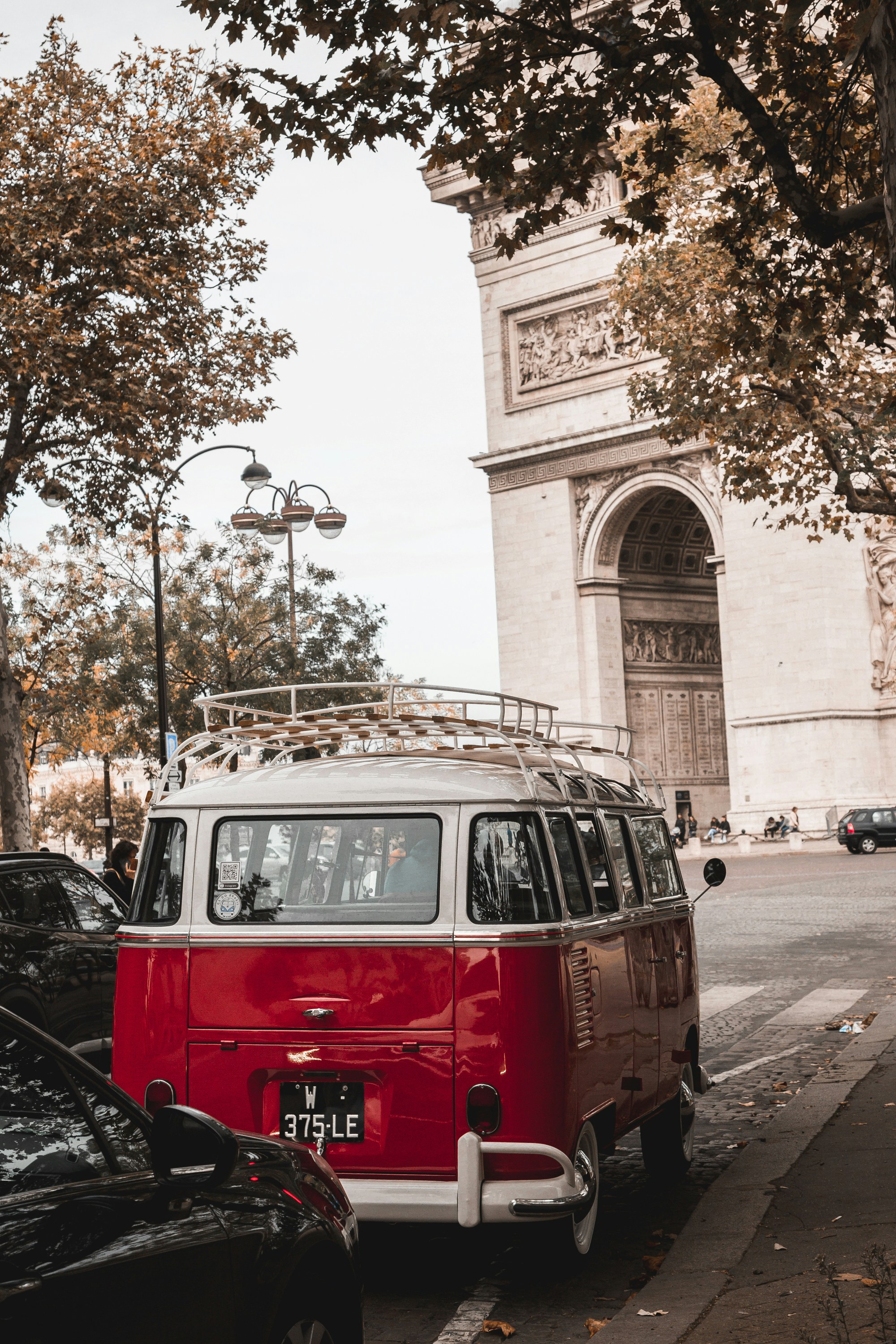 Red VW Bus Anchors a Paris Moment Under the Arc de Triomphe