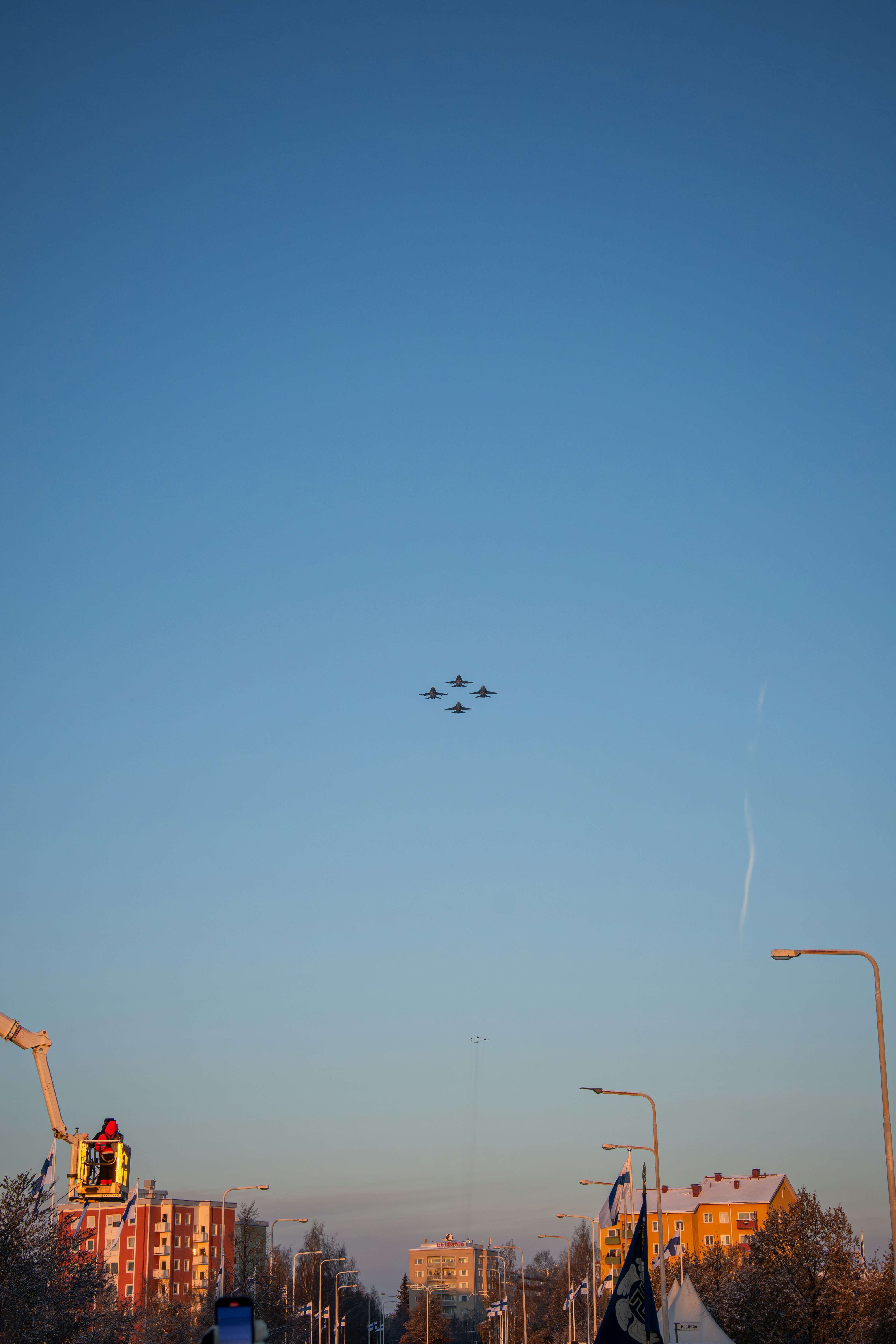 V formation over the city: six jets skim the blue morning sky