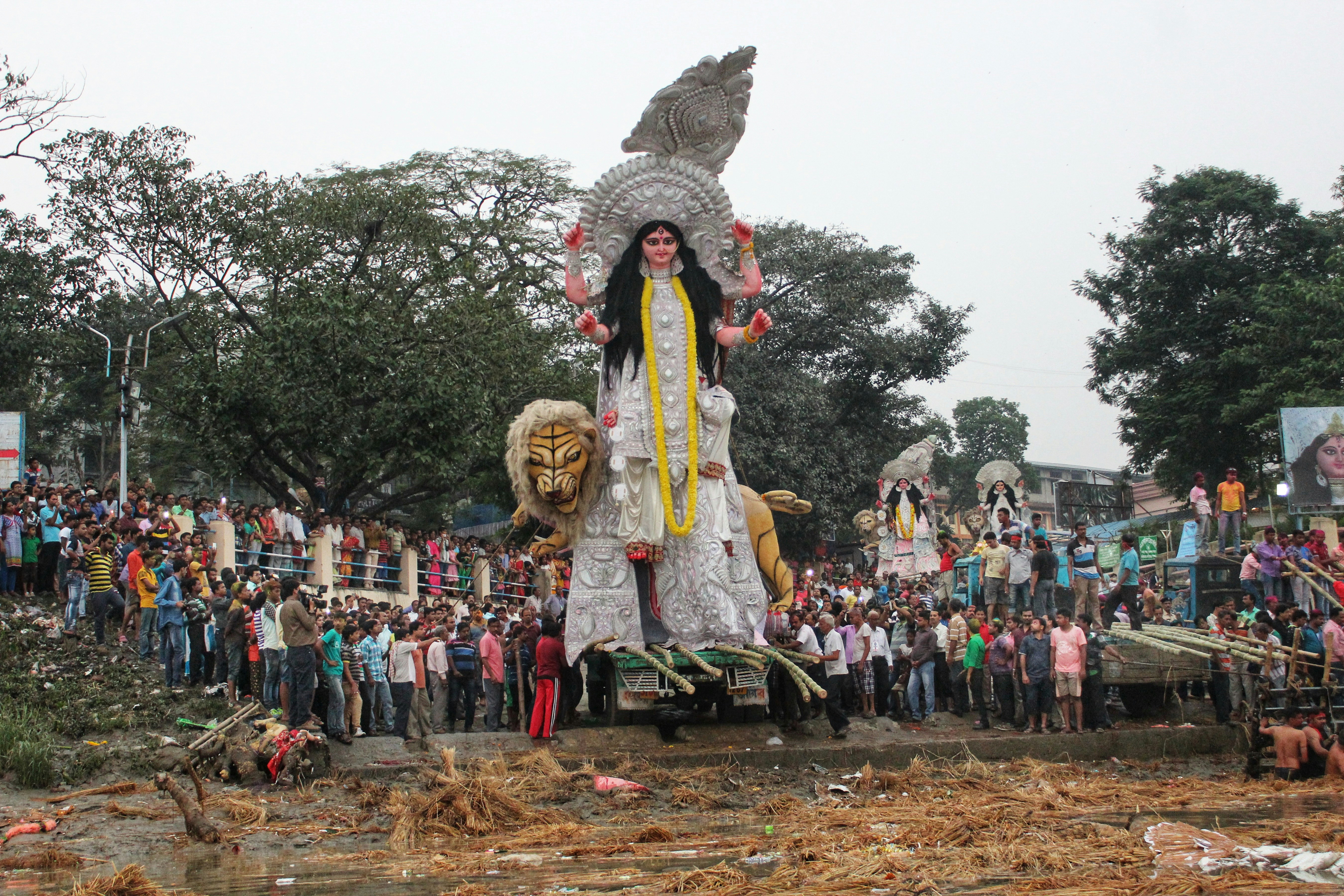 Procession Giant: A towering statue glides above a cheering crowd