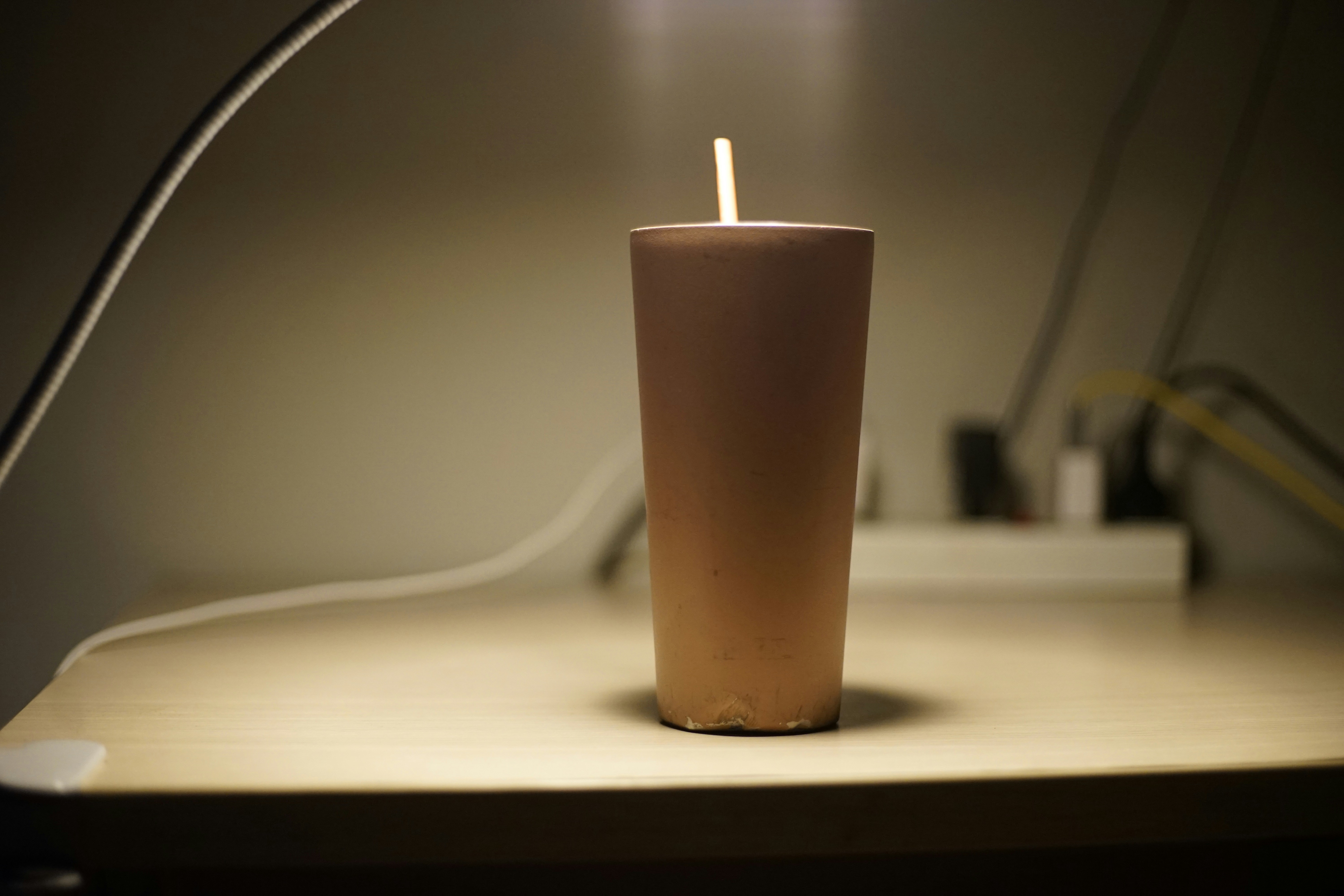 Amber Candle on a Quiet Desk: A Moment of Warm Focus