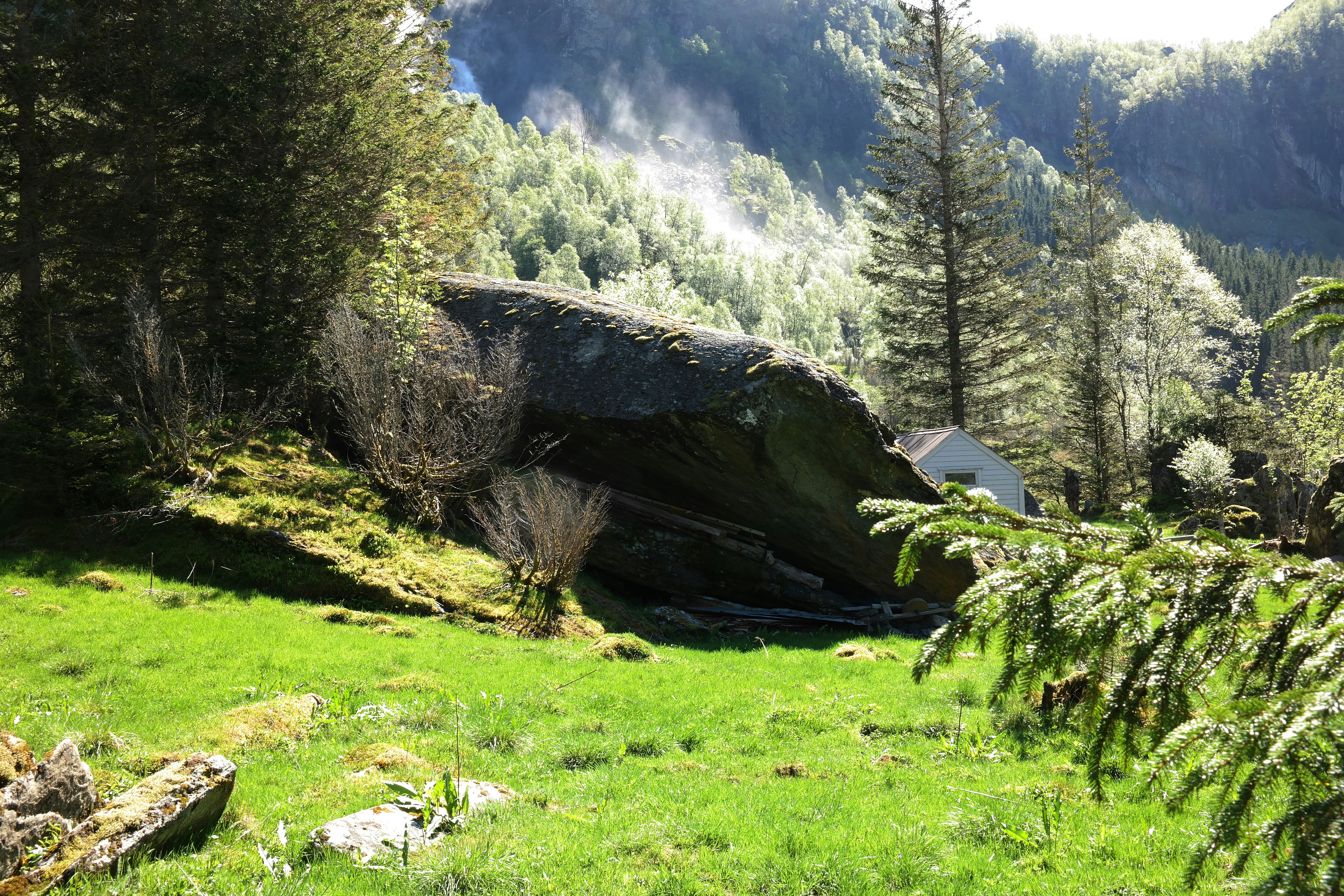 A large rock in the middle of a grassy field photo – Free Norway Image ...