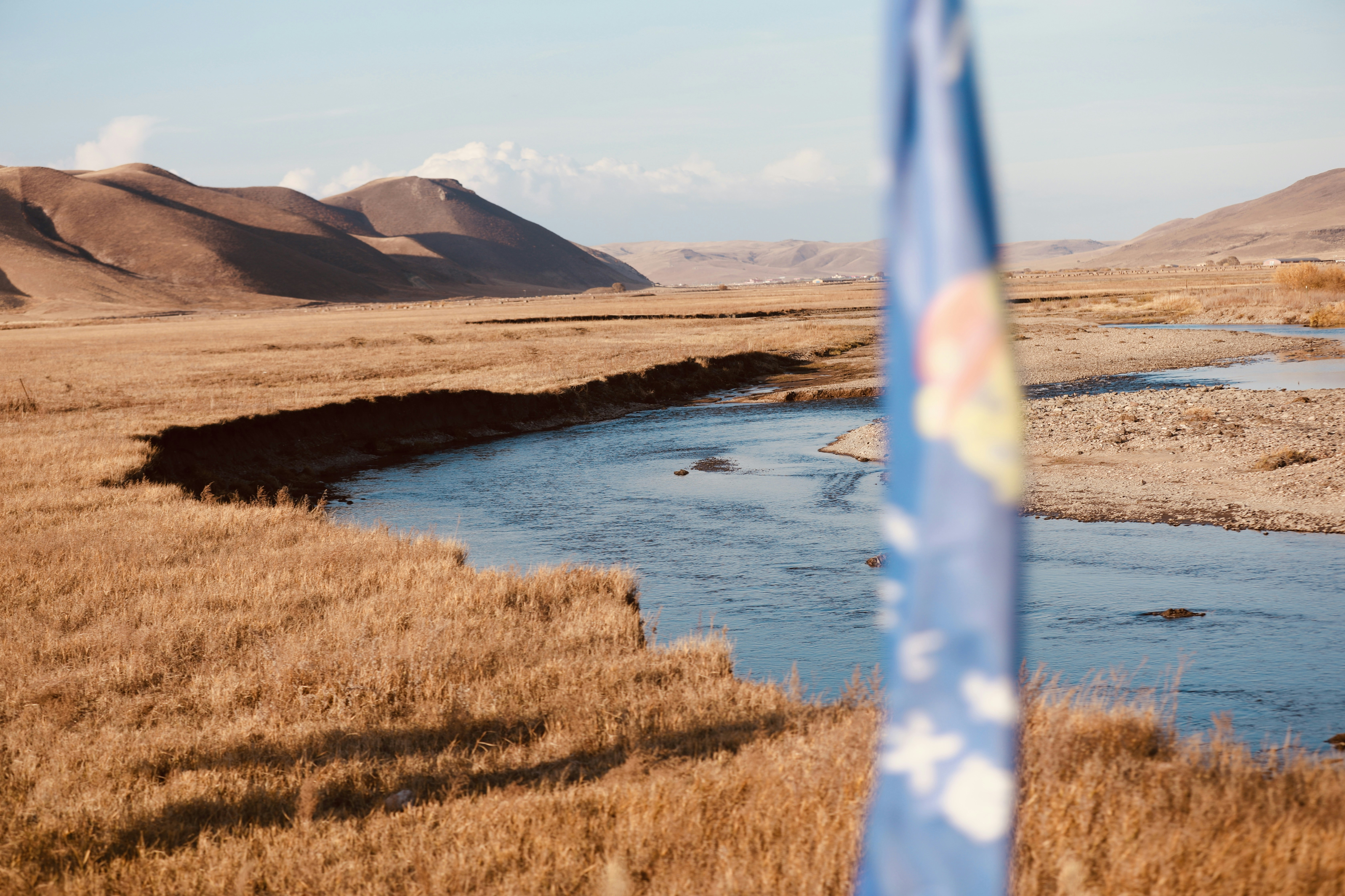 A stream running through a dry grass covered field photo – Free Inner ...
