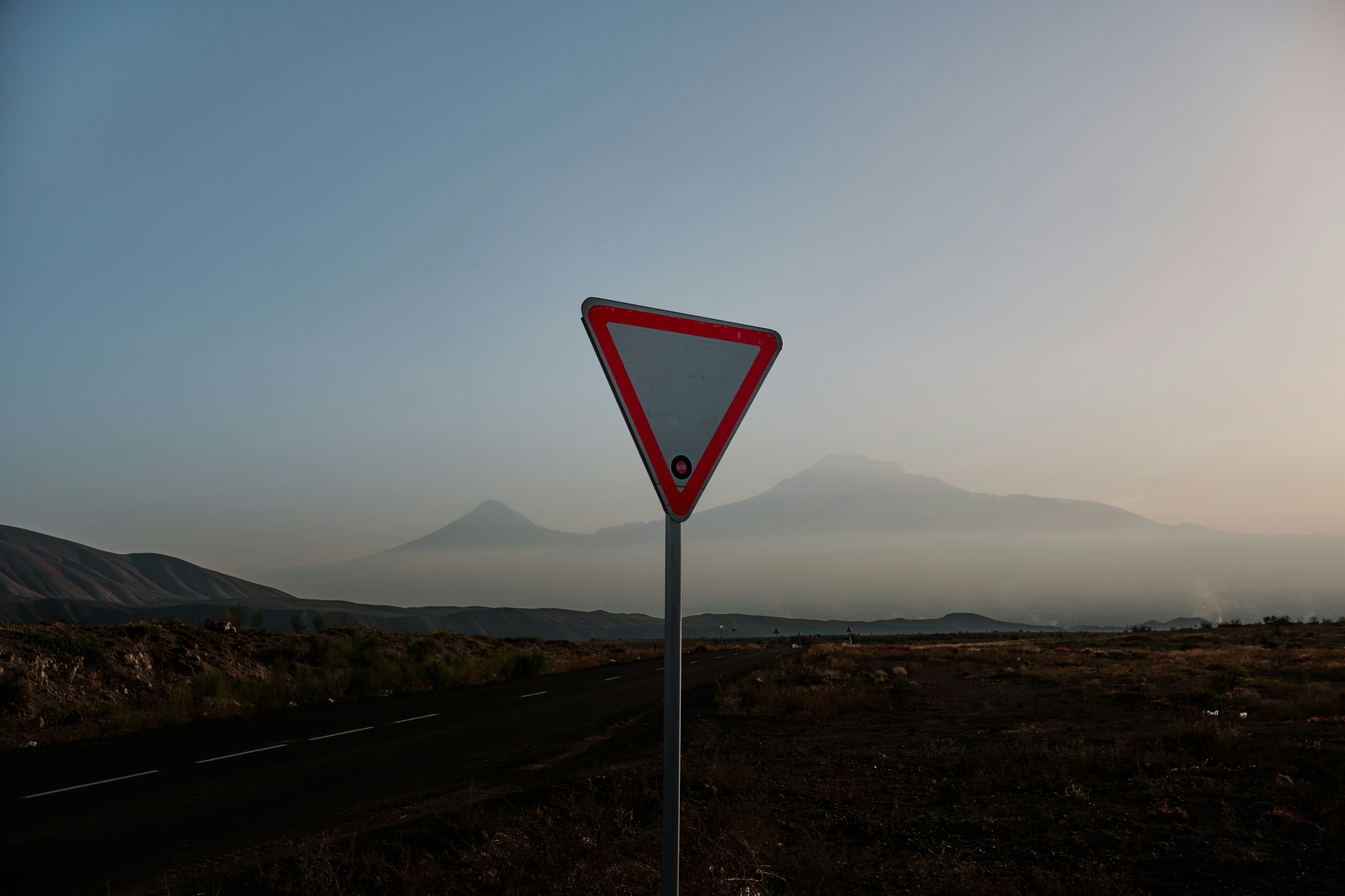 a red and white street sign sitting on the side of a road