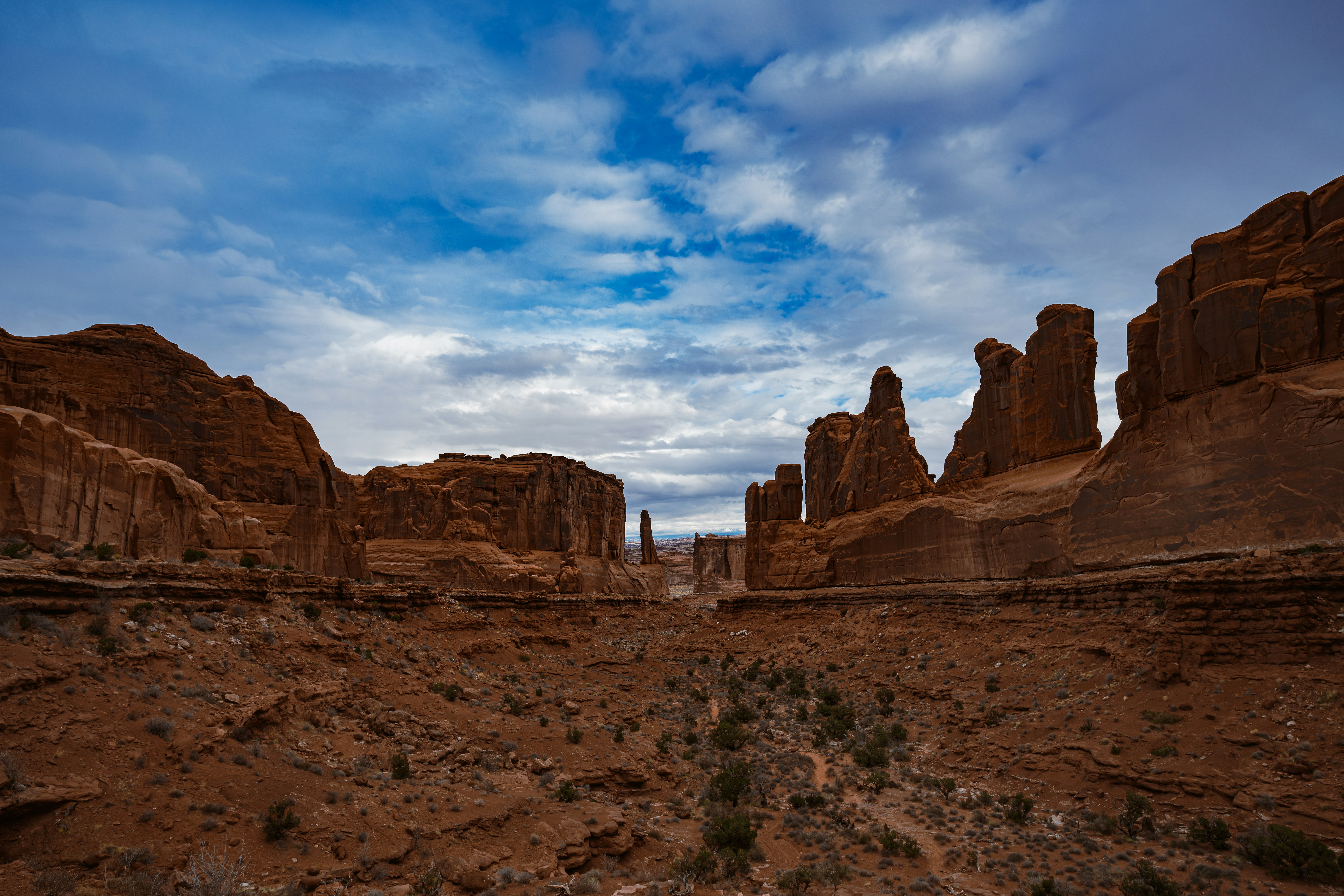 A desert landscape with rocks and a blue sky photo – Free Clouds Image ...