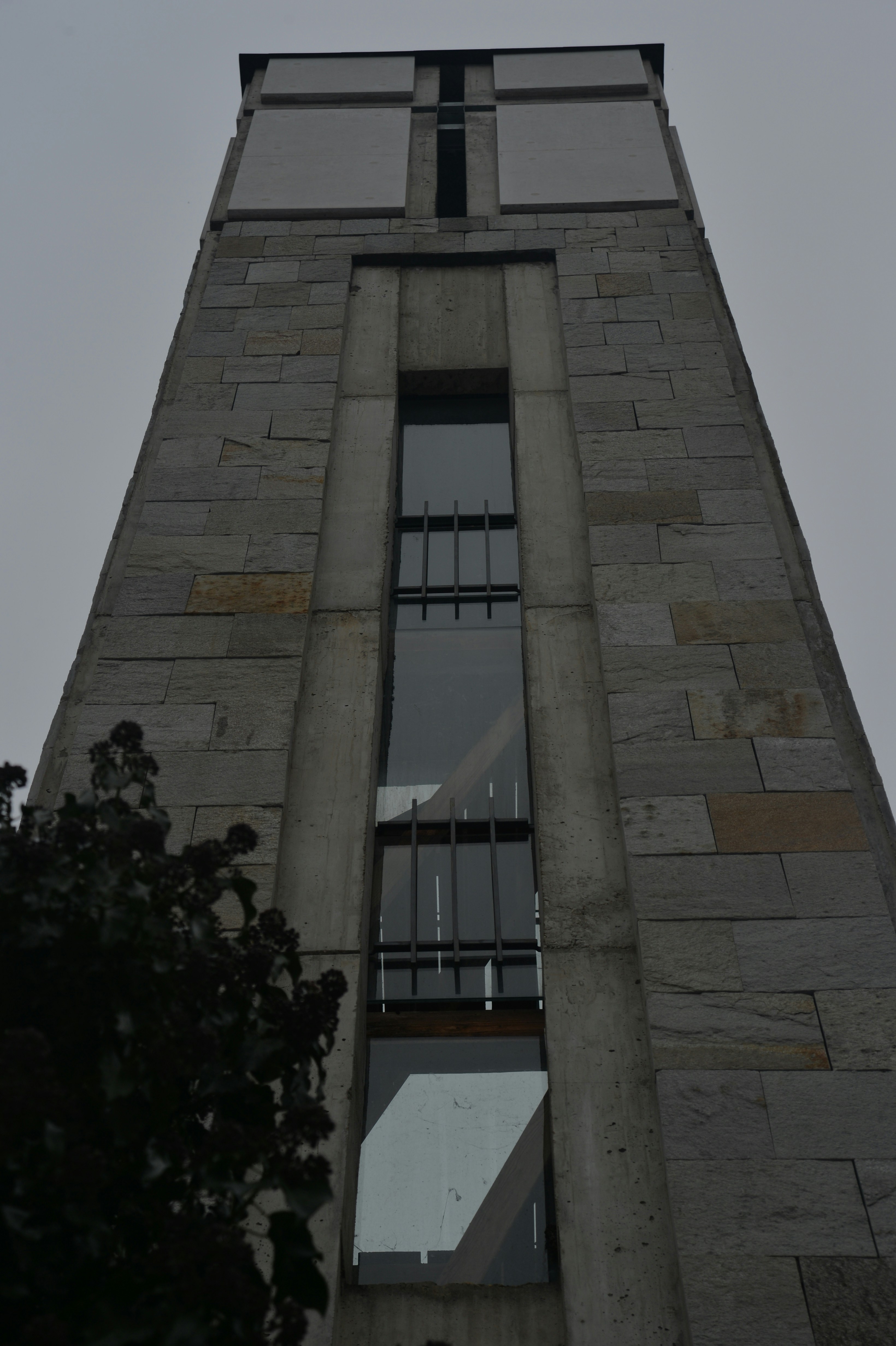 Vertical Gaze: The Central Window in a Grey Stone Tower