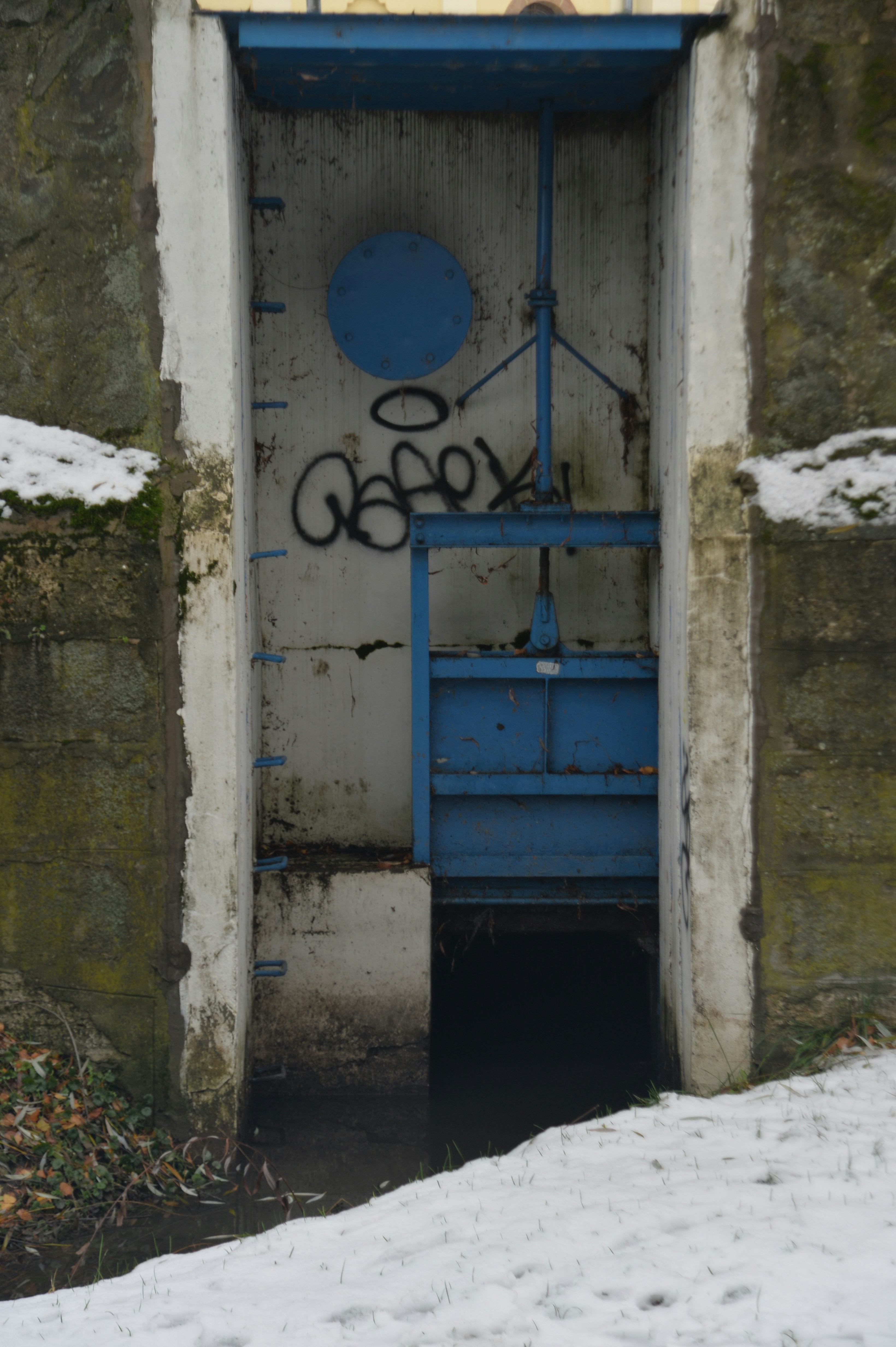Winter Gate at a Weathered Canal Lock: Blue Steel, Snow, and Graffiti