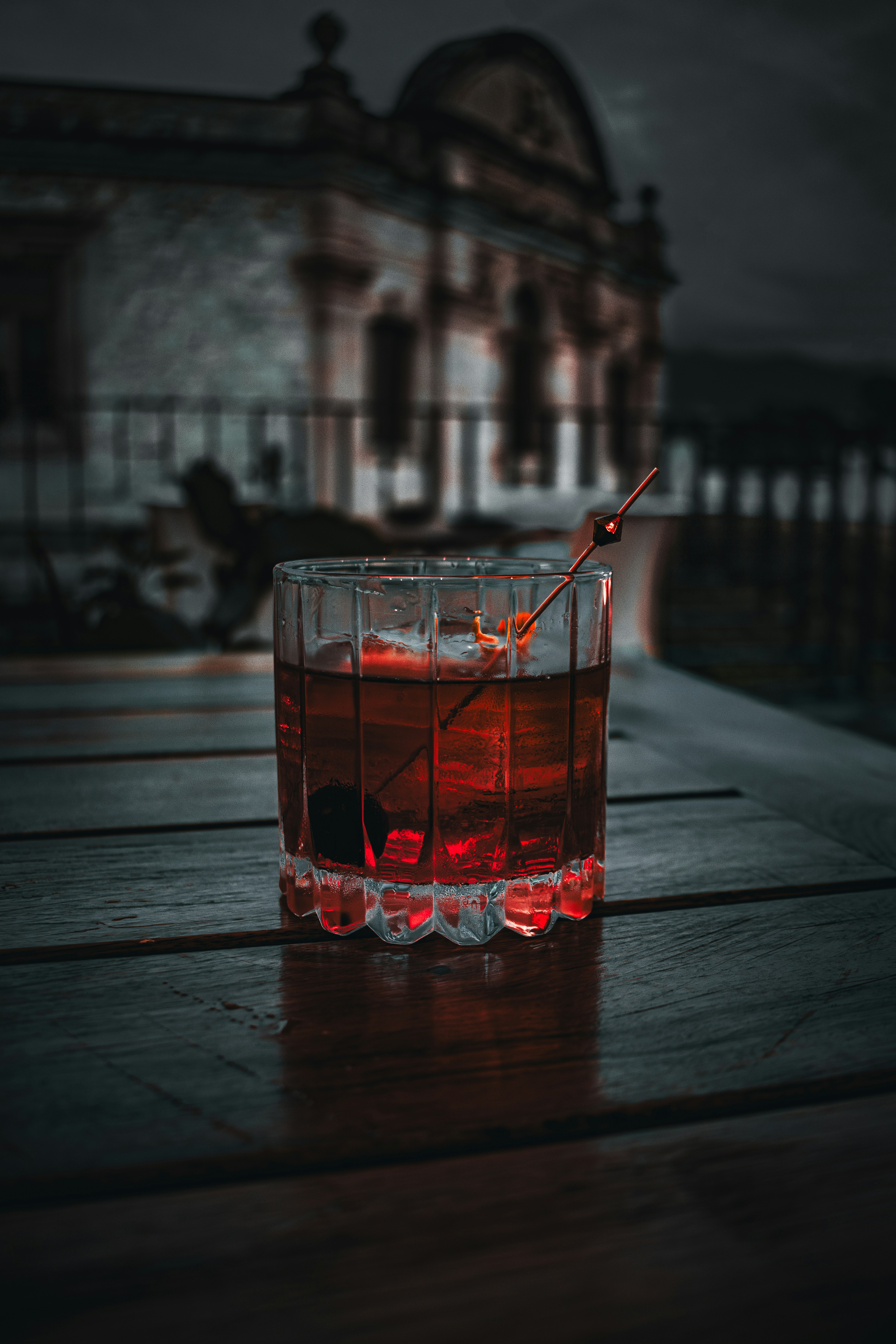 Crimson Chill on a Weathered Terrace at Dusk