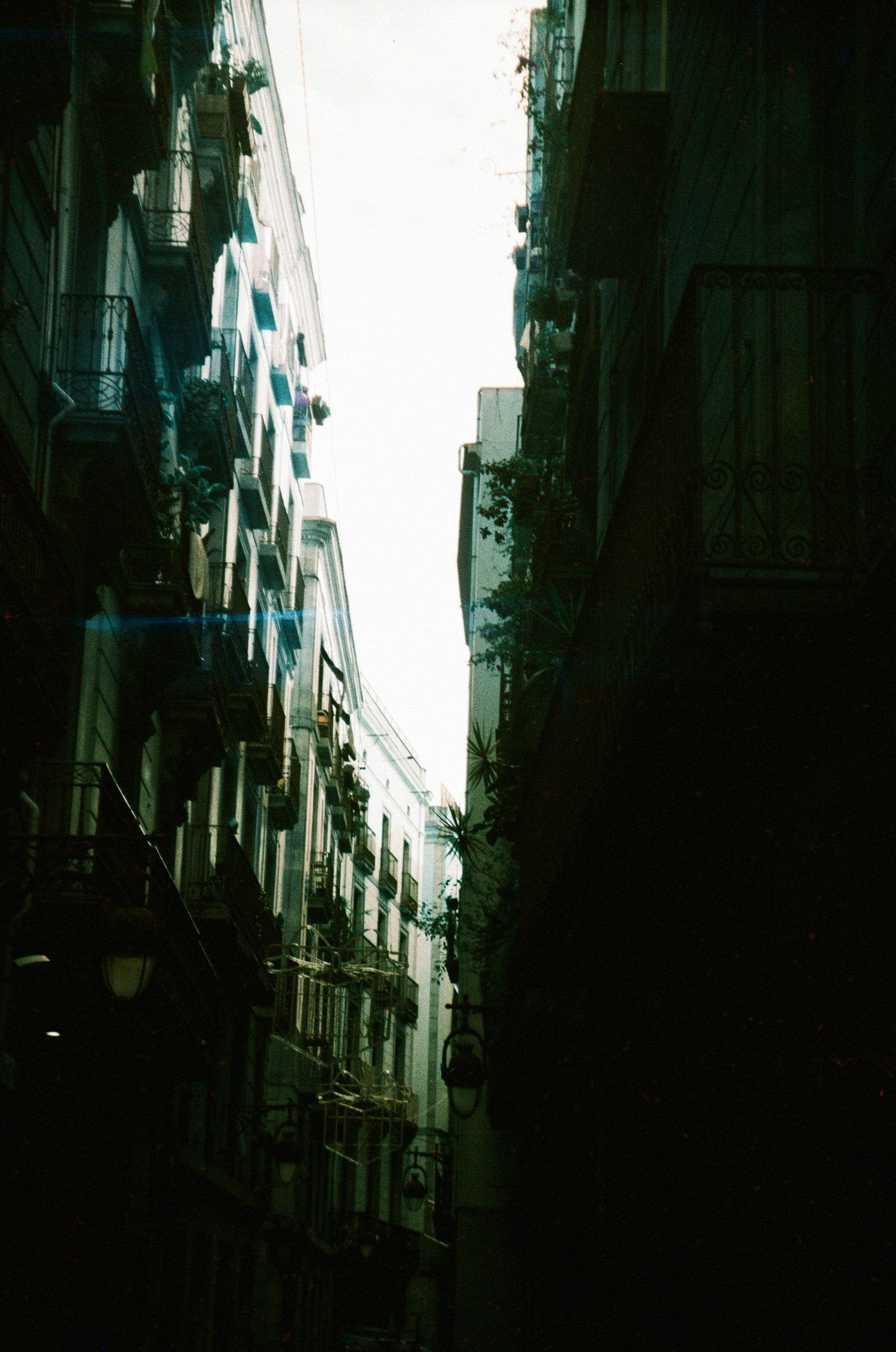 A narrow city street with tall buildings on both sides photo – Free ...