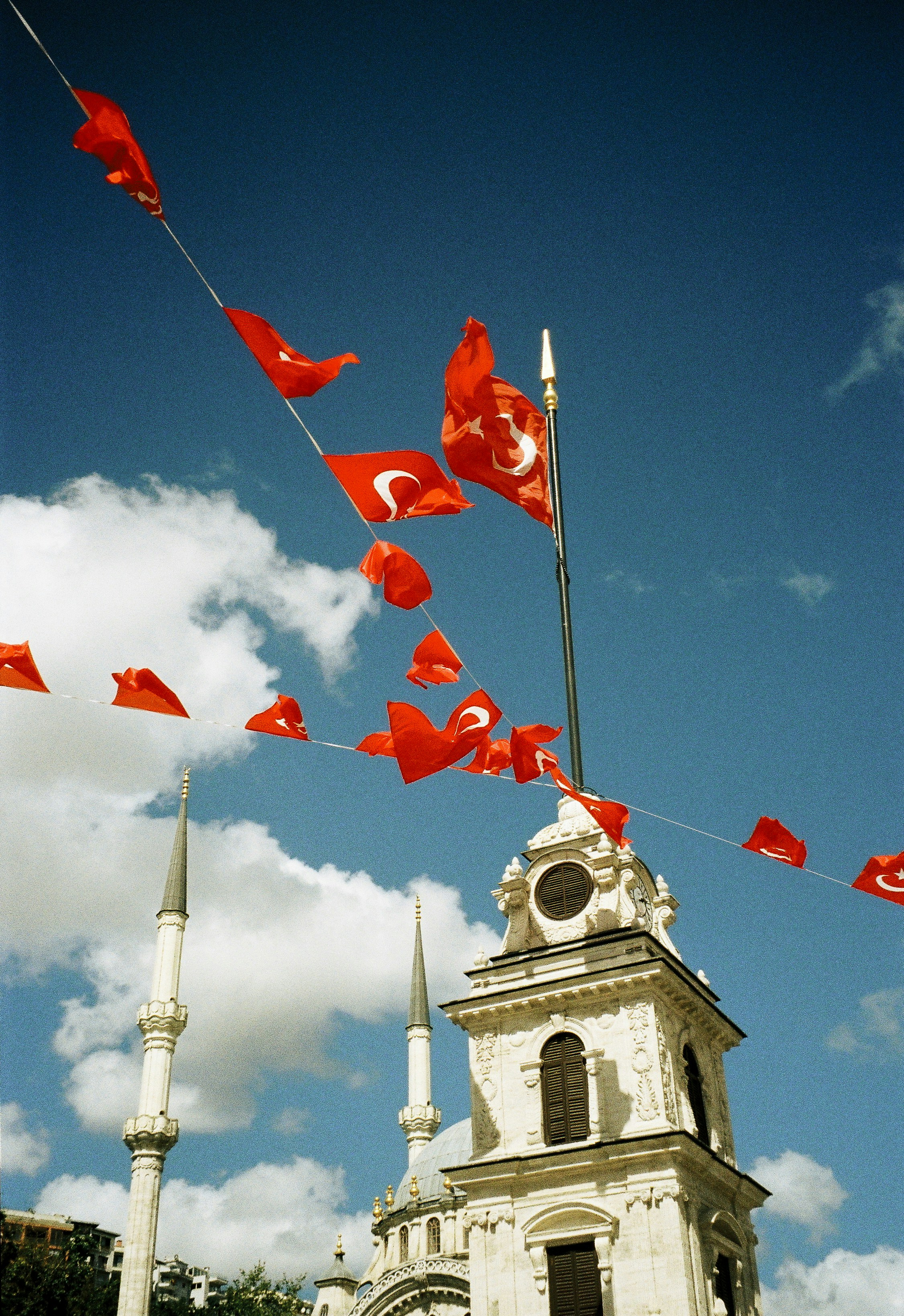 Turkish flags flying in front of monument in istanbul