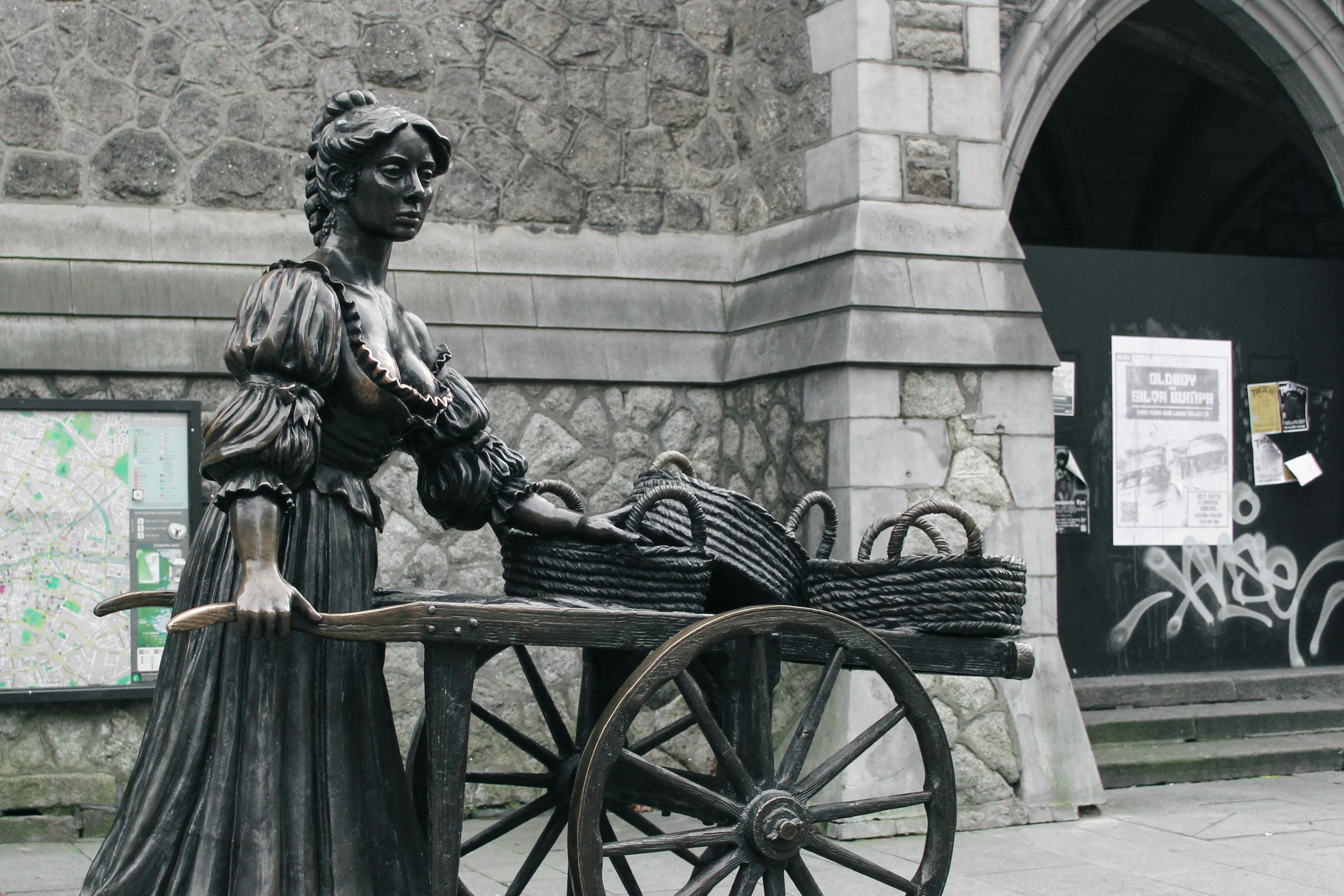 A statue of a woman pushing a baby carriage photo – Free Grey Image on ...