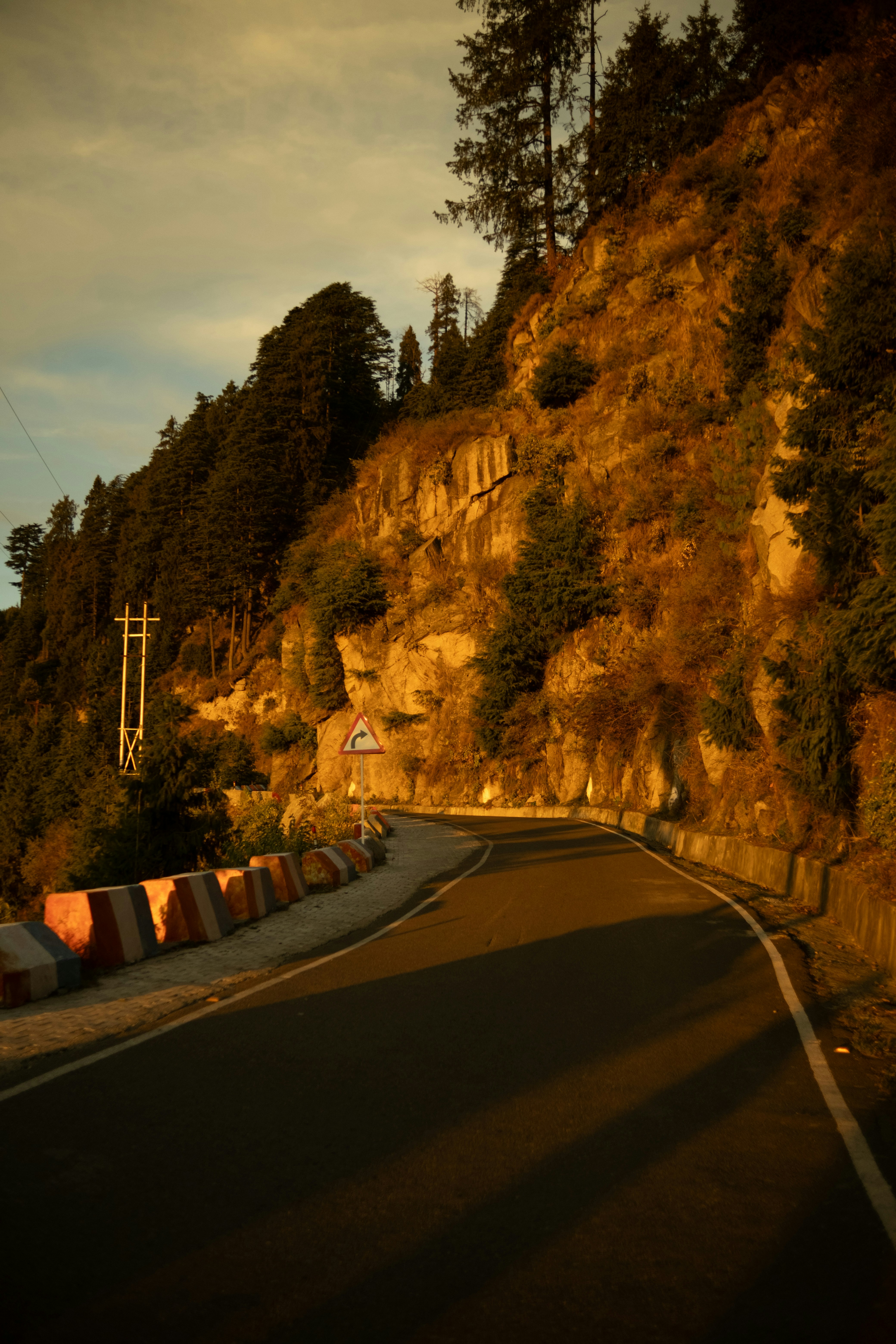 Amber Curve: A Mountain Road Wrapped in Cliffside Light