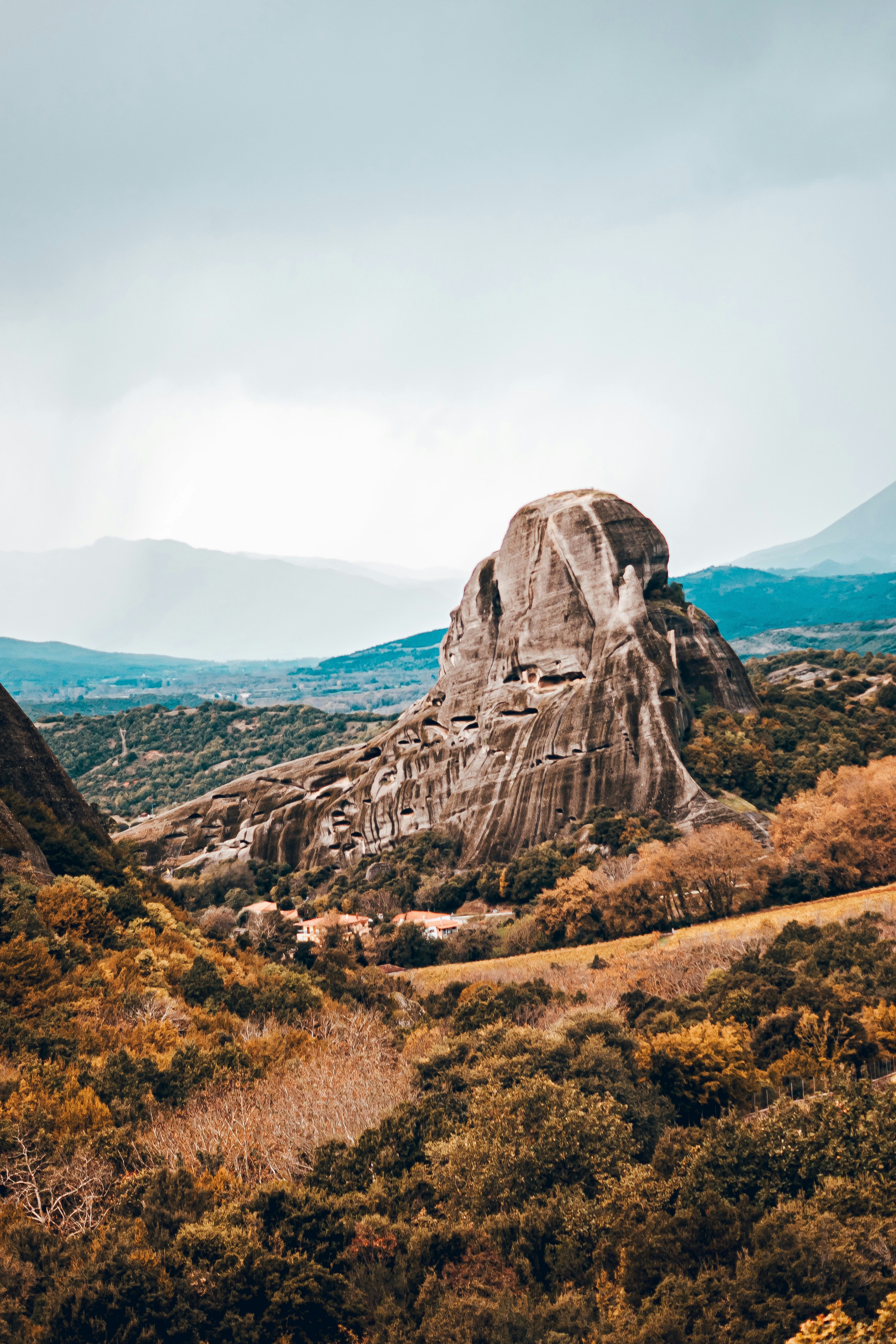 Monolithic Sentinel: A Pale Rock Beckons Over Autumn Hills