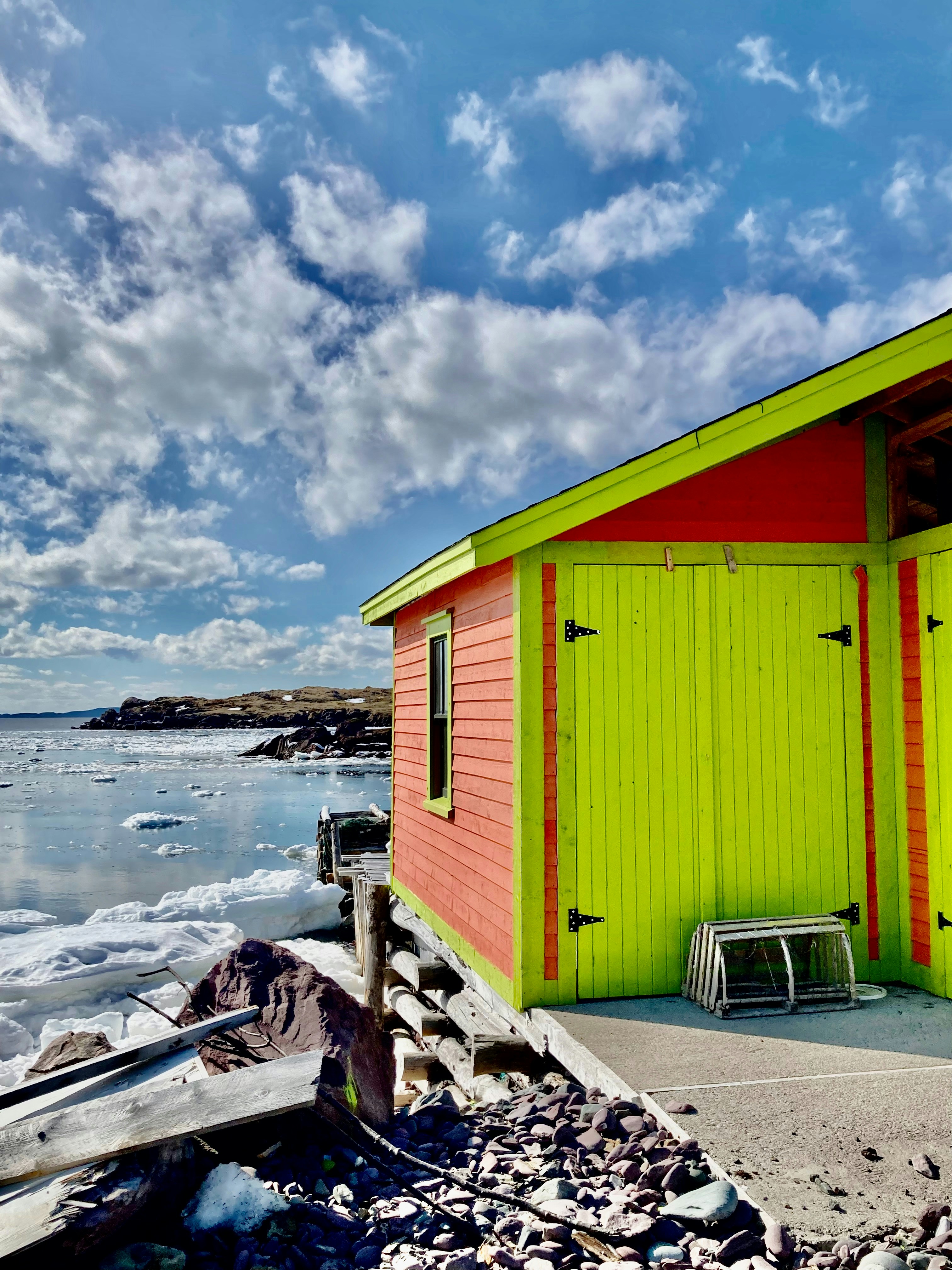 Lime‑Green Shoreline Cottage Against Azure Sky