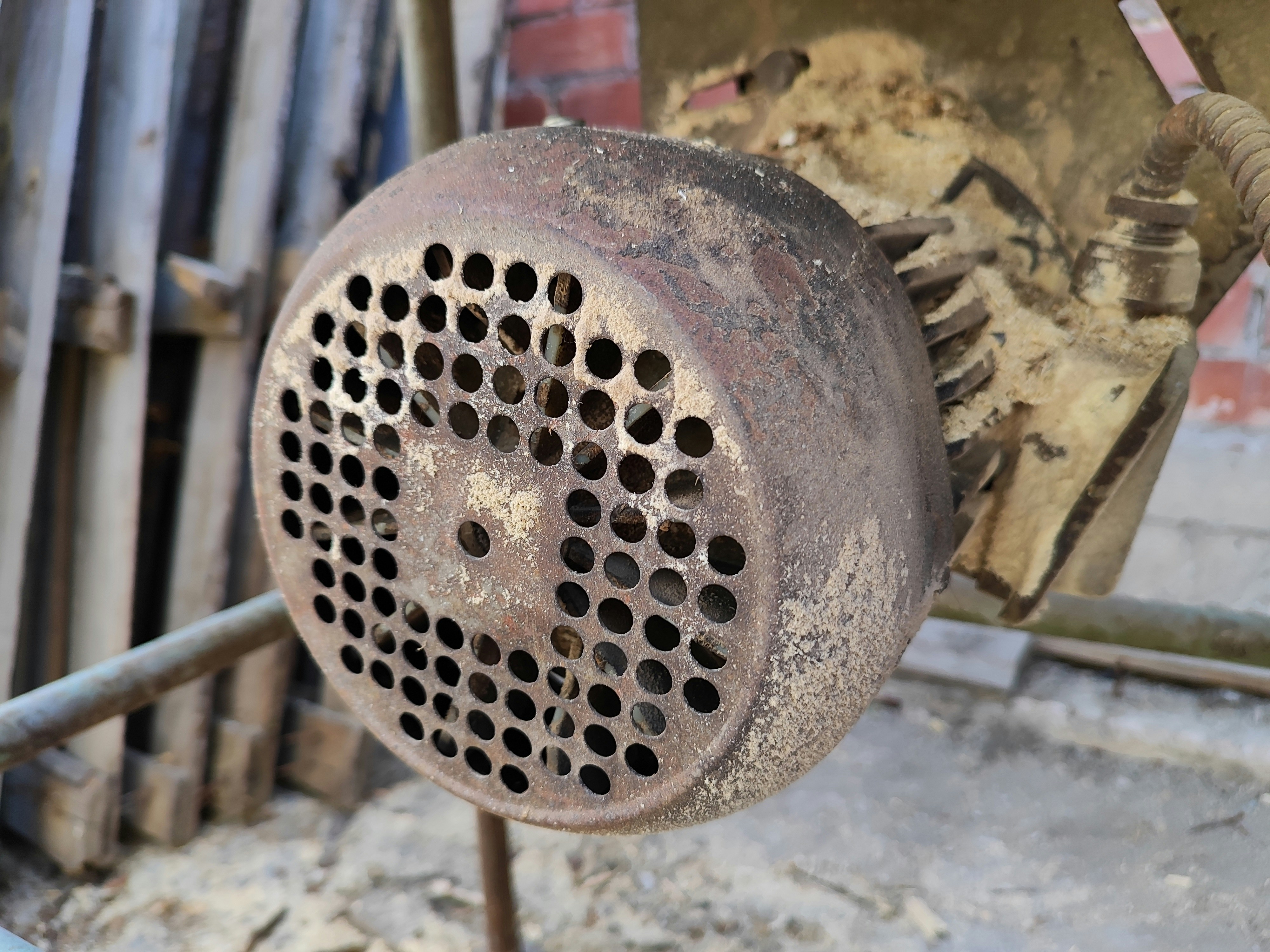 A rusted metal object sitting on top of a pile of junk photo – Free ...