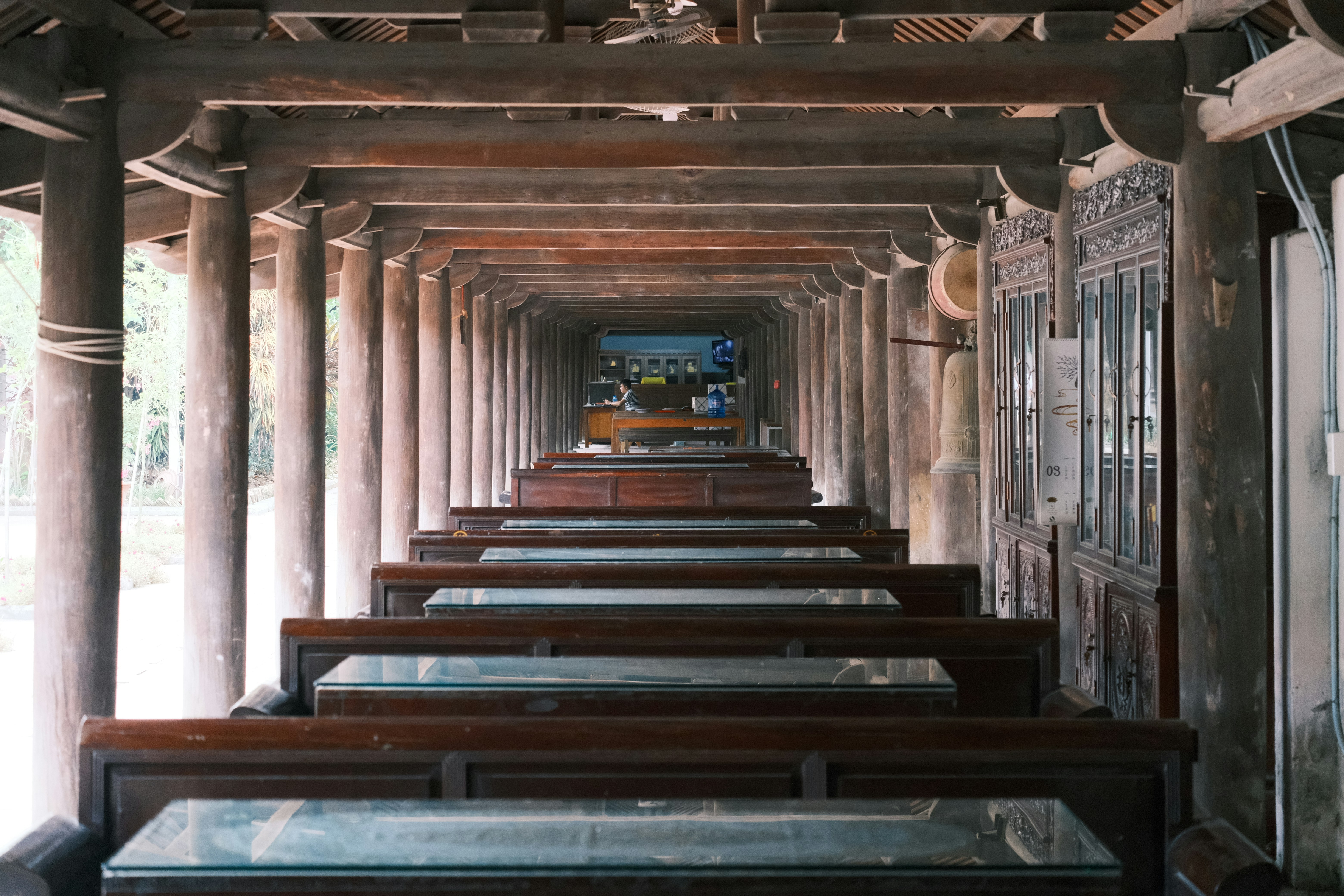 Endless Timber: A Silent Corridor Leading to a Blue-Illuminated Exit