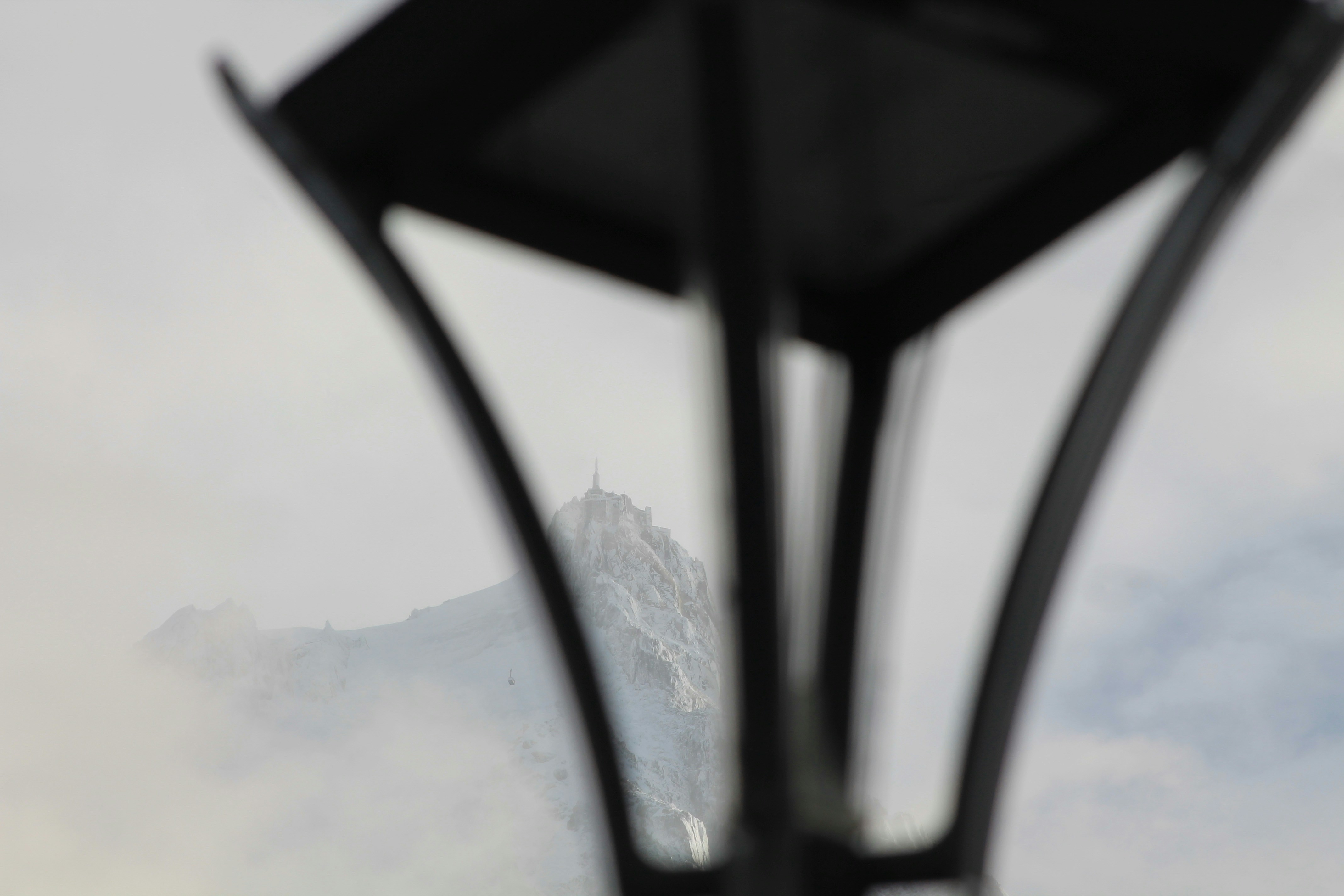 Framed Summit: Peak Peeking Through a Fog-Softened Lantern Frame