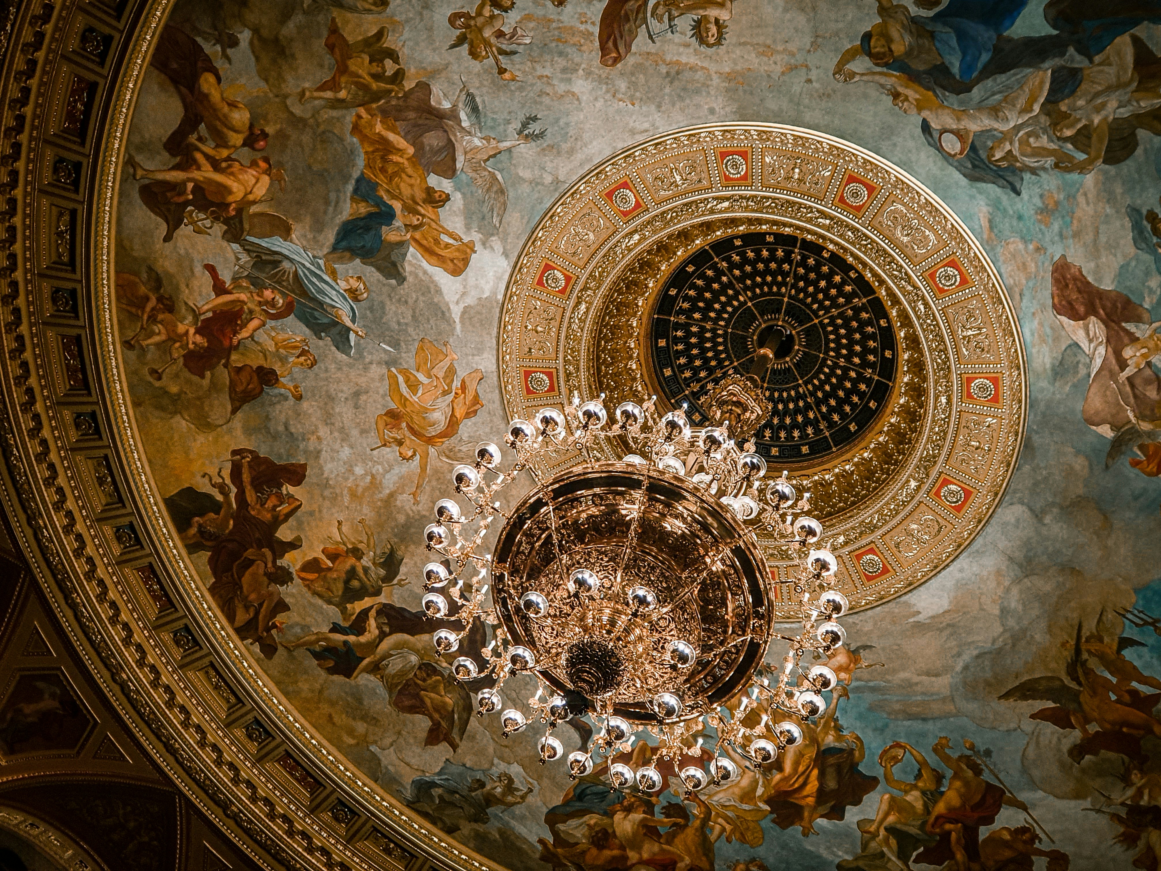 A chandelier hanging from the ceiling of a building photo – Free ...