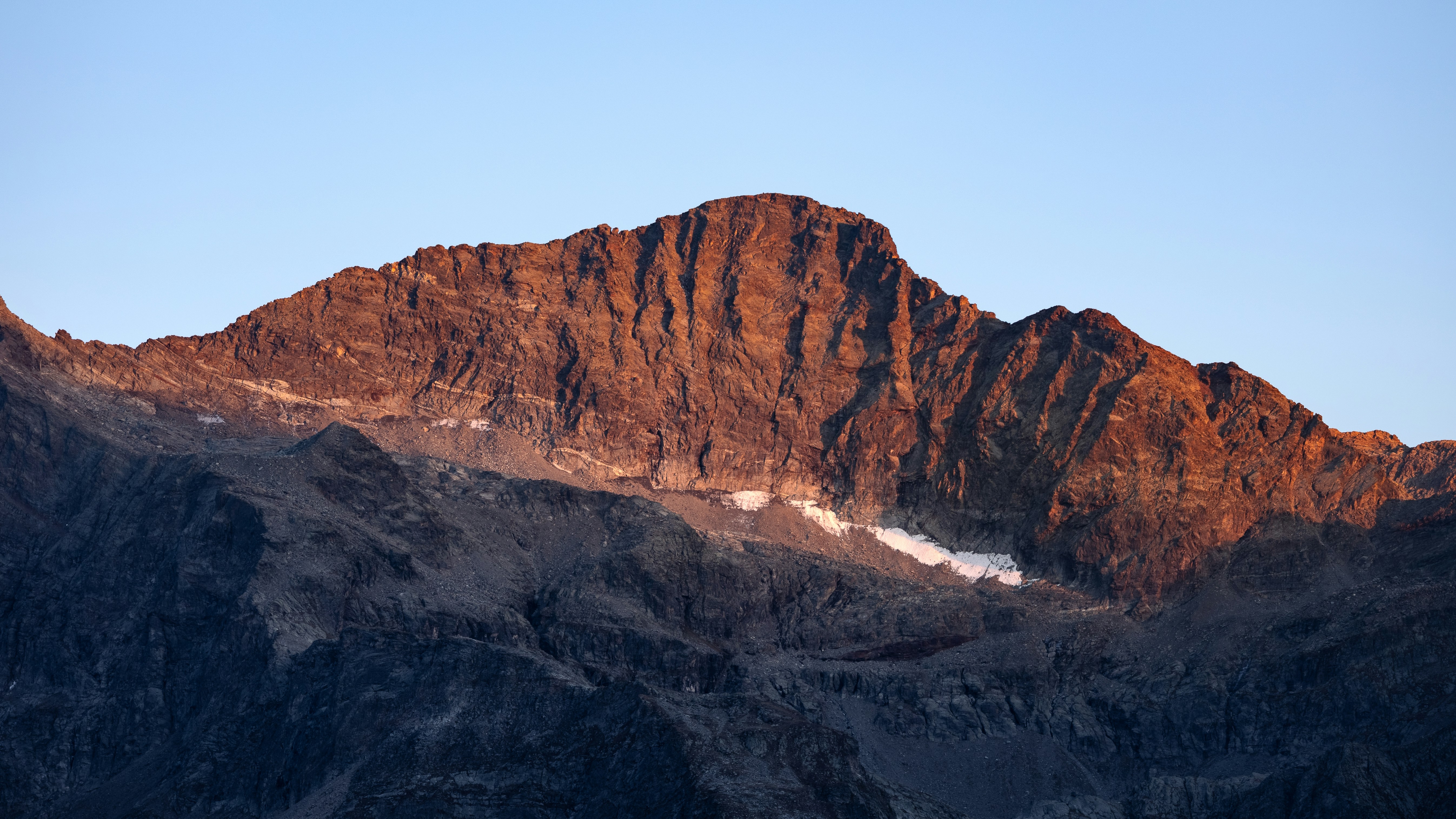 A very tall mountain with some snow on it photo – Free Nature Image on ...