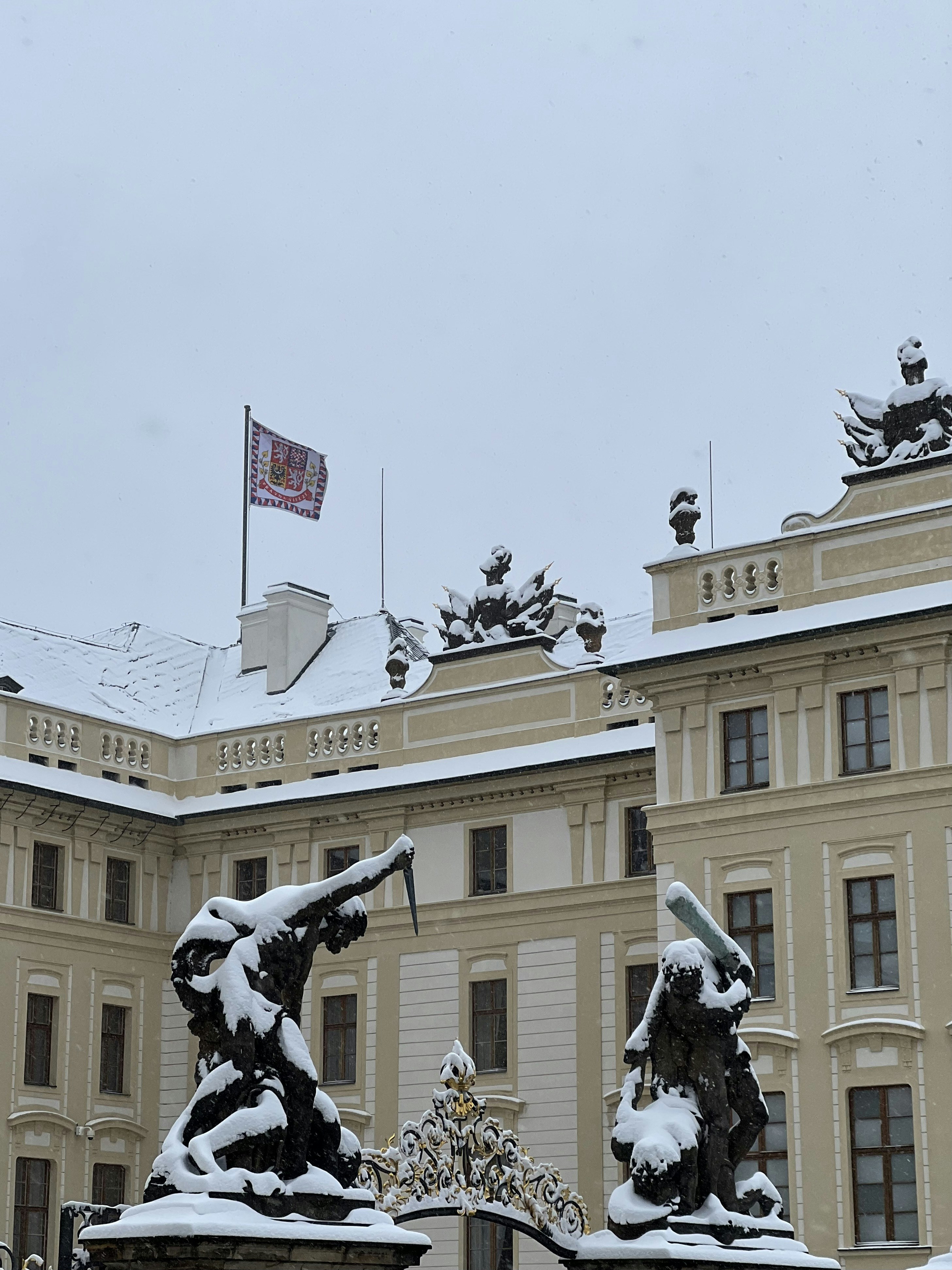 Snowbound Baroque Courtyard: Frosted Statues Beneath a Pale Winter Sky