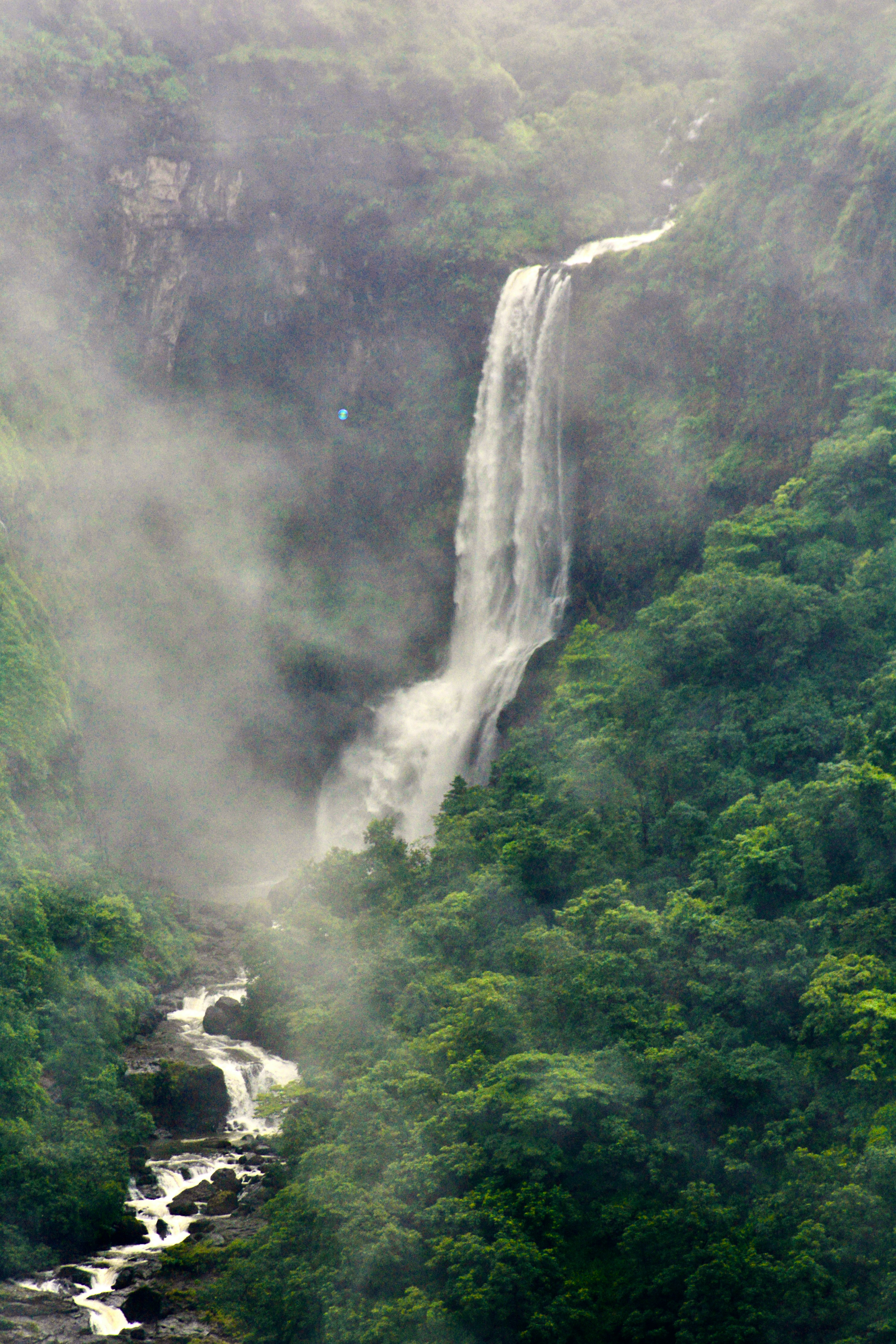 Verdant Gorge Waterfall Veiled in Mist