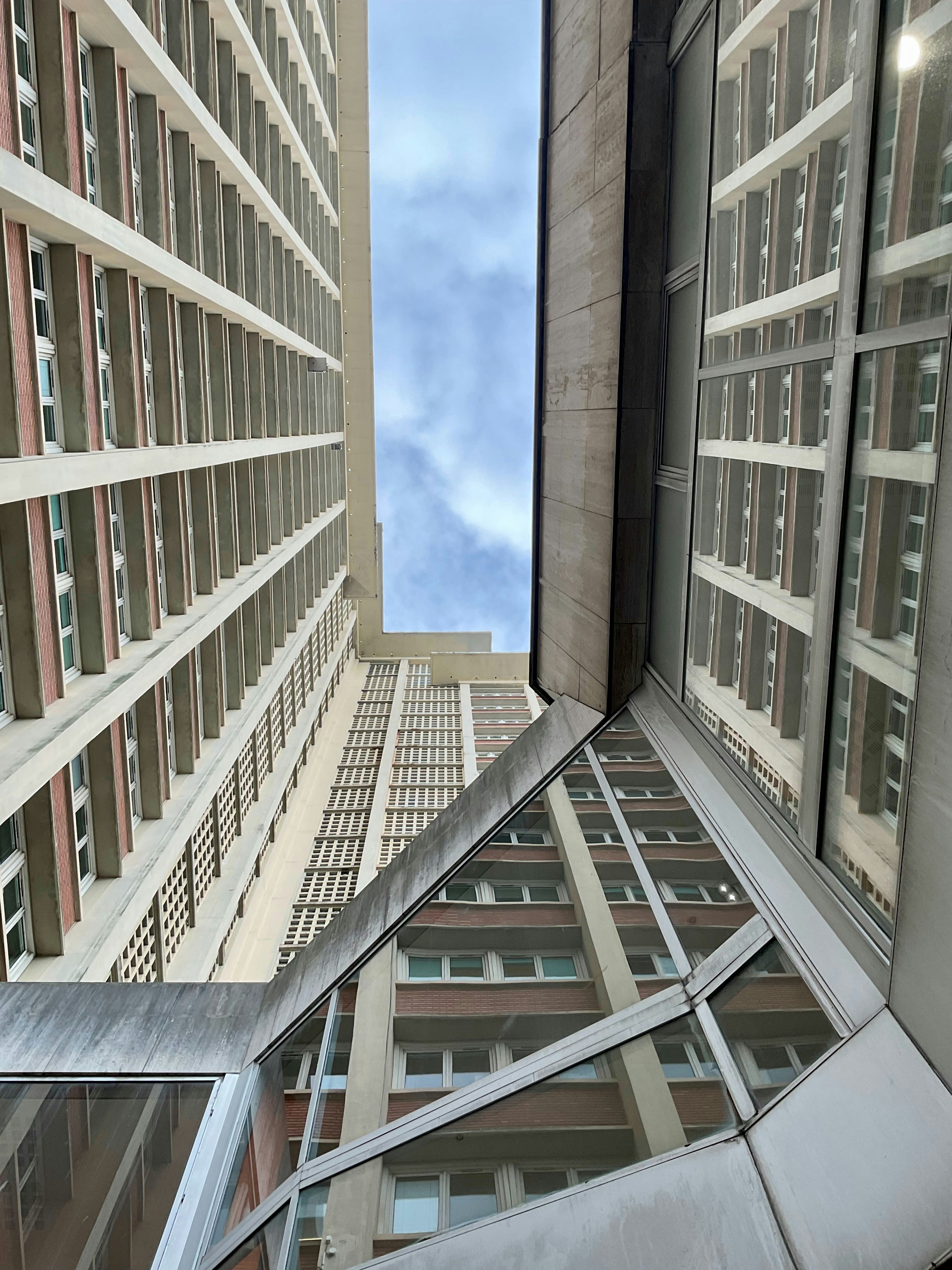 A view of a very tall building from the ground photo – Free Building ...