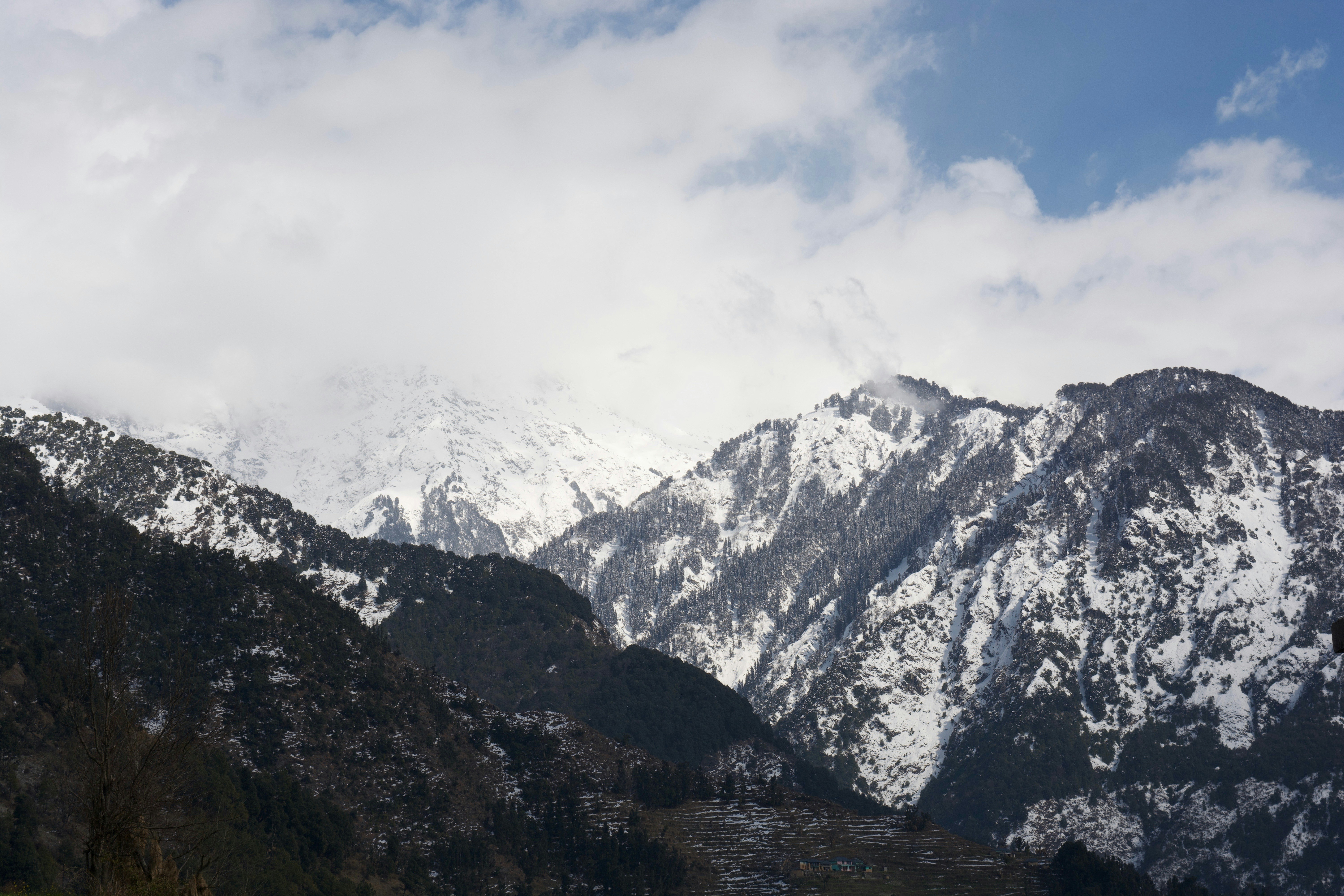 Snow-Crested Ridge Under a Cloud-Flecked Sky