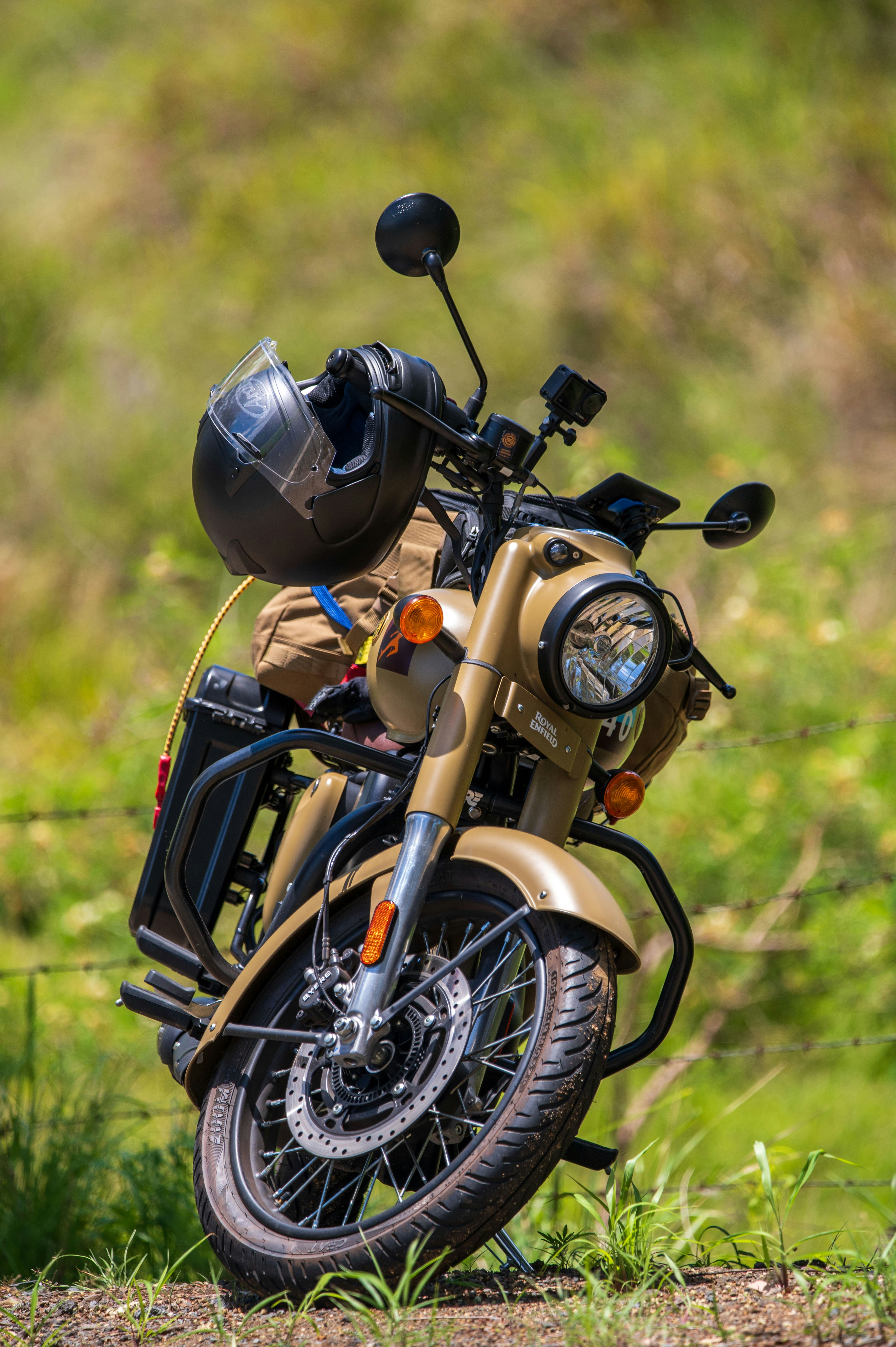 Golden Moment: A Vintage Motorcycle Leaning into the Meadow