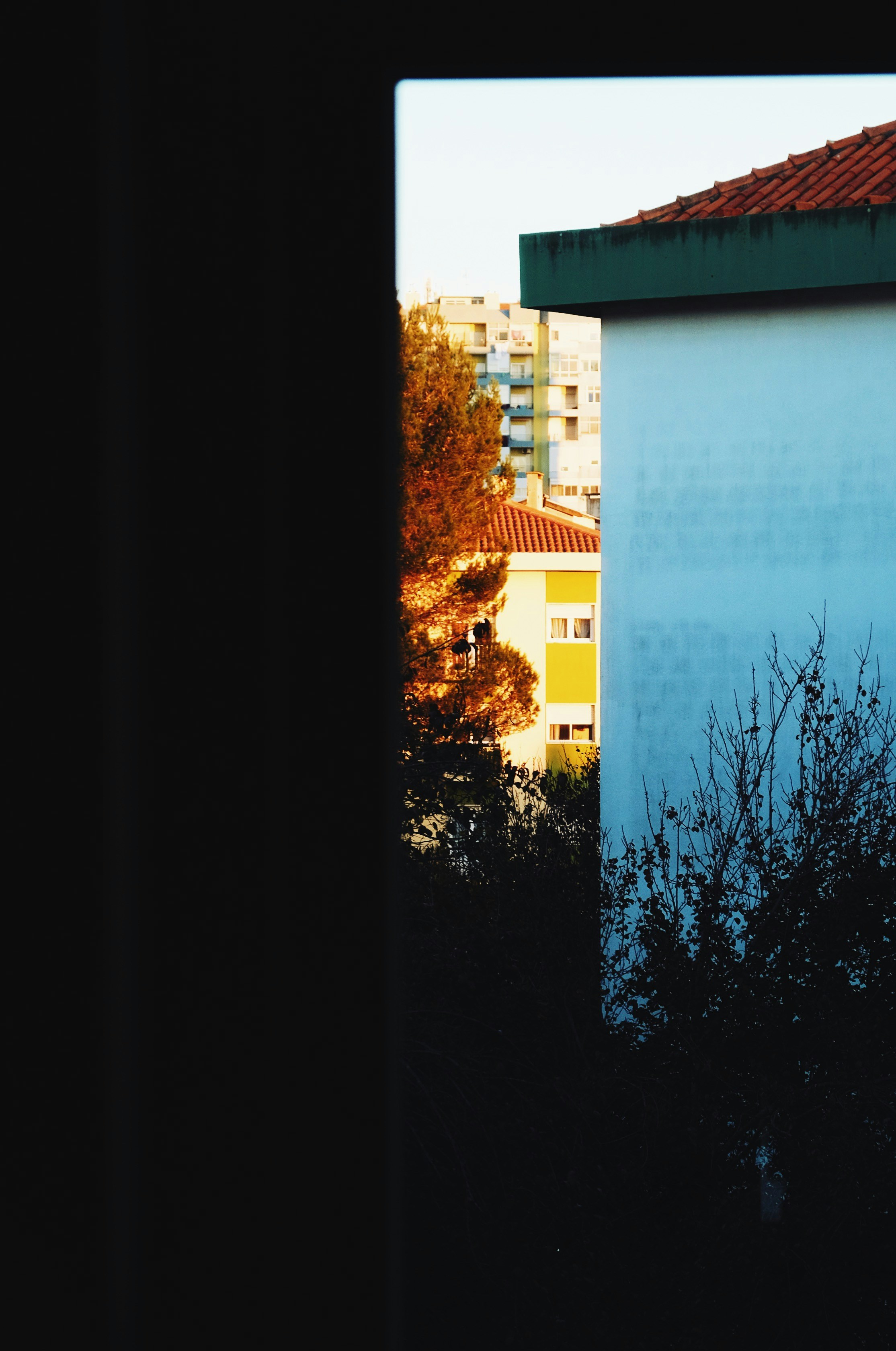 A view of a building through a window photo – Free Portugal Image on ...