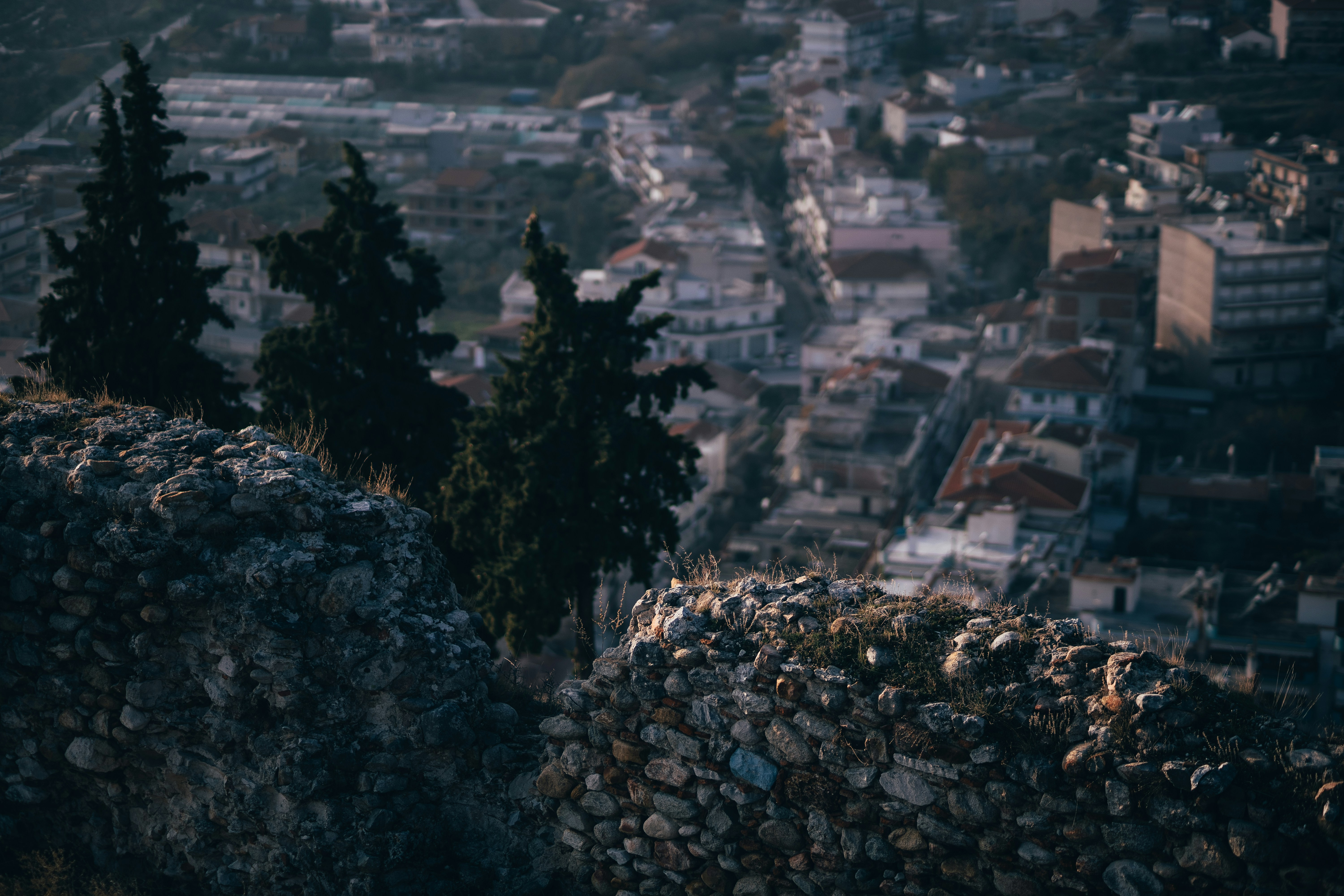 Sunlit Verge: Stone Edge Overlooking a Quiet Hilltown