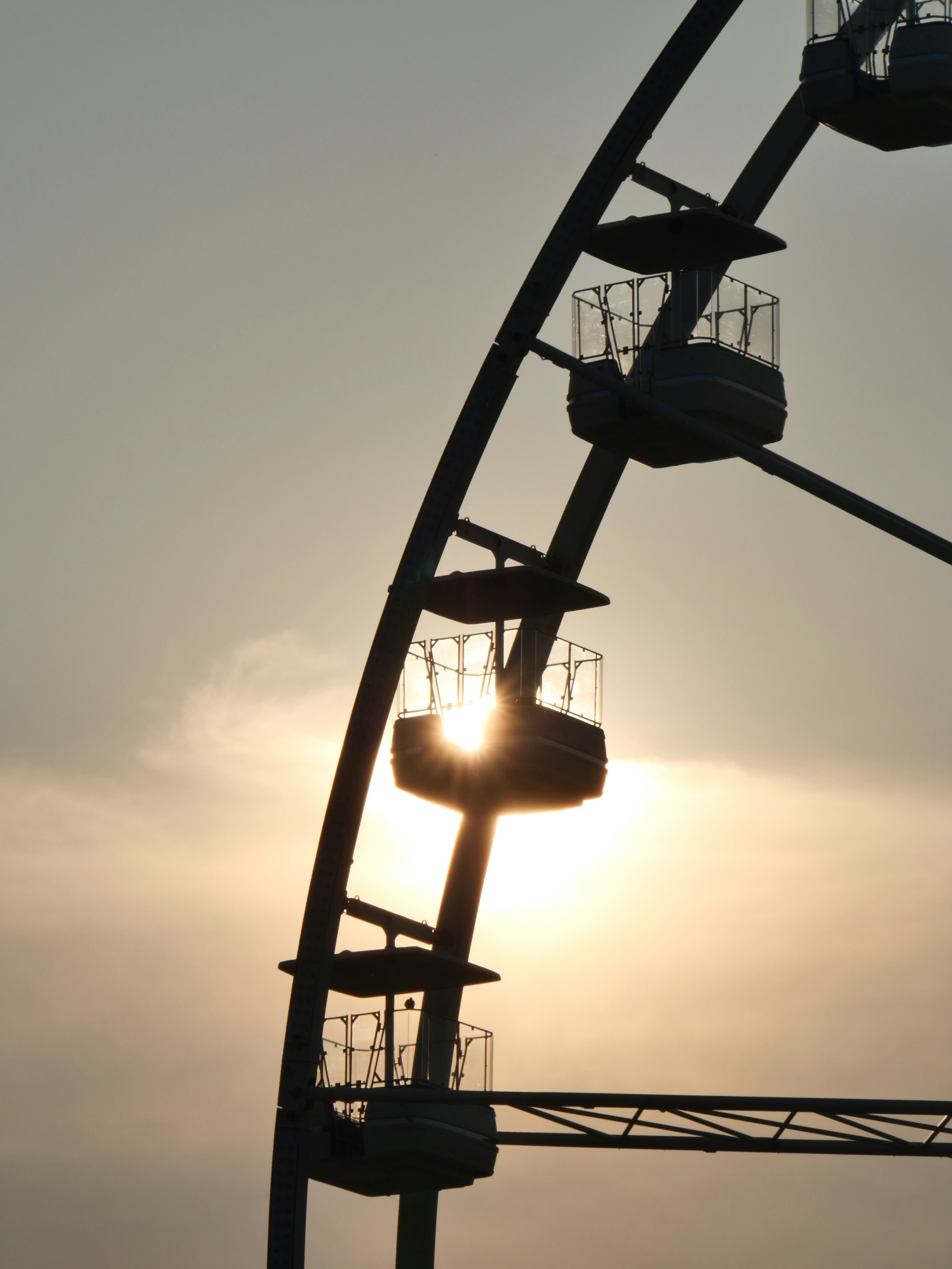 Sunburst Through a Ferris Wheel: Dusk Silhouette