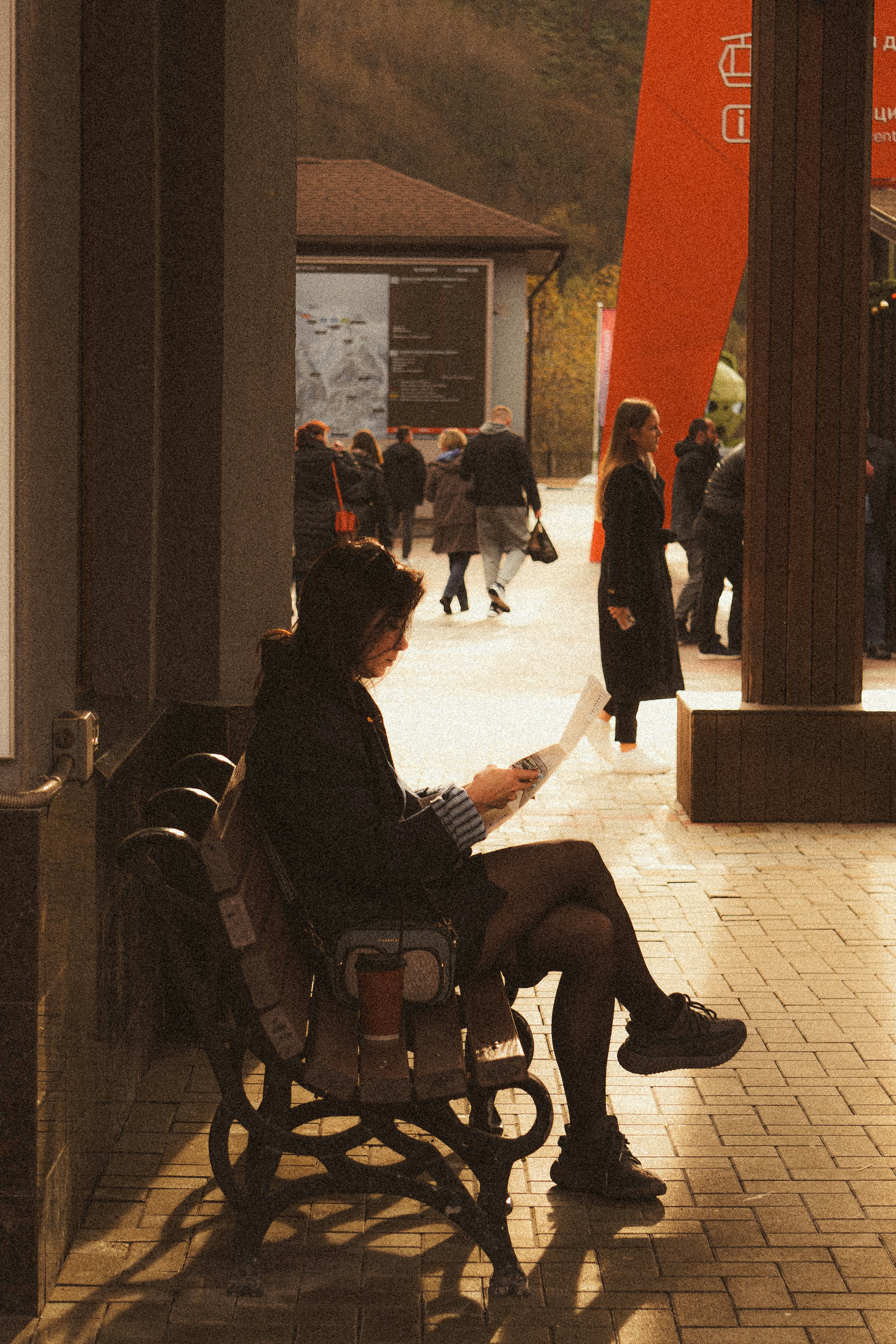 Paper and Pedestrians: A Quiet Minute on a Sunlit City Plaza