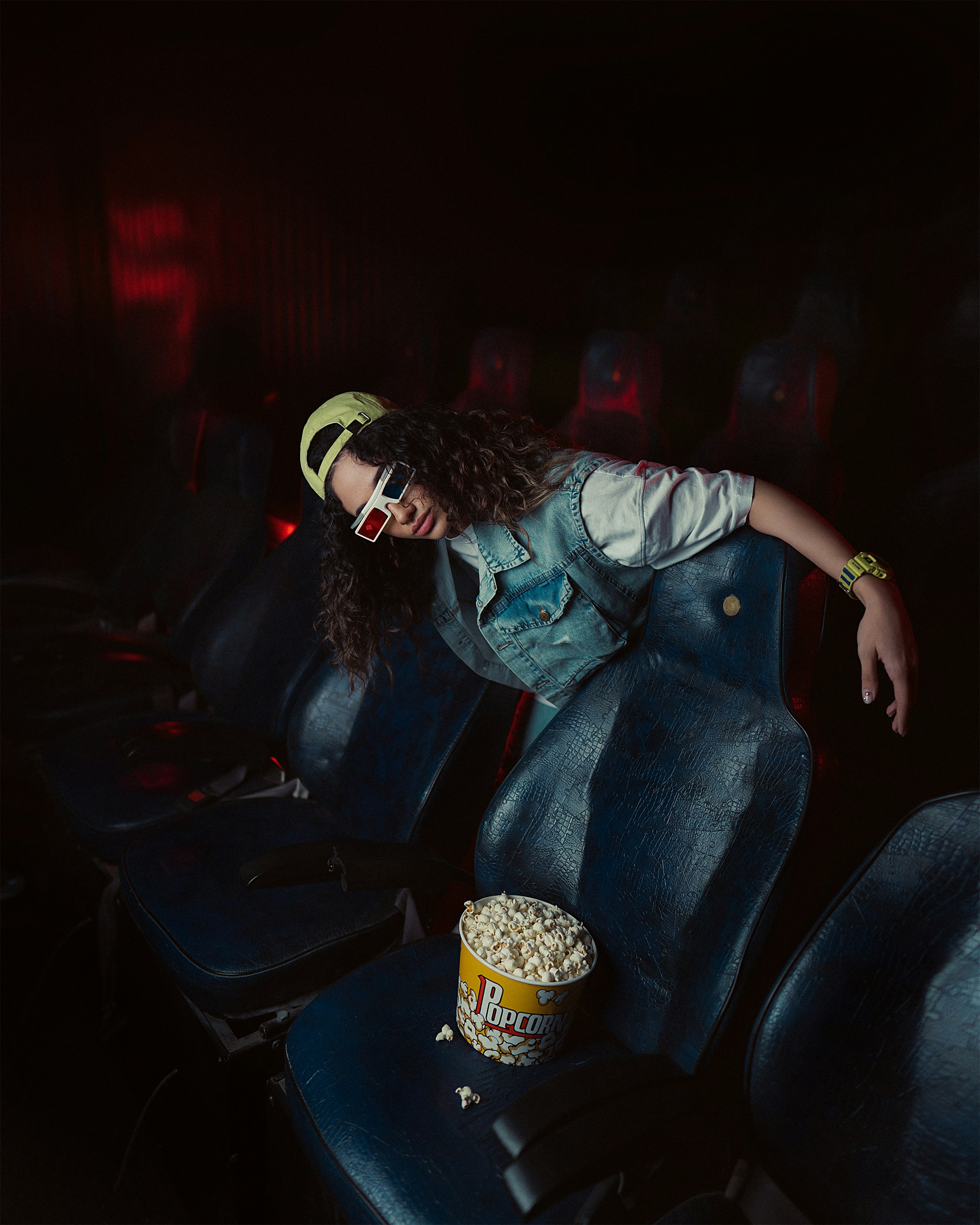 Neon Noir in the Back Row: Denim and Popcorn Under Red Cinema Lights