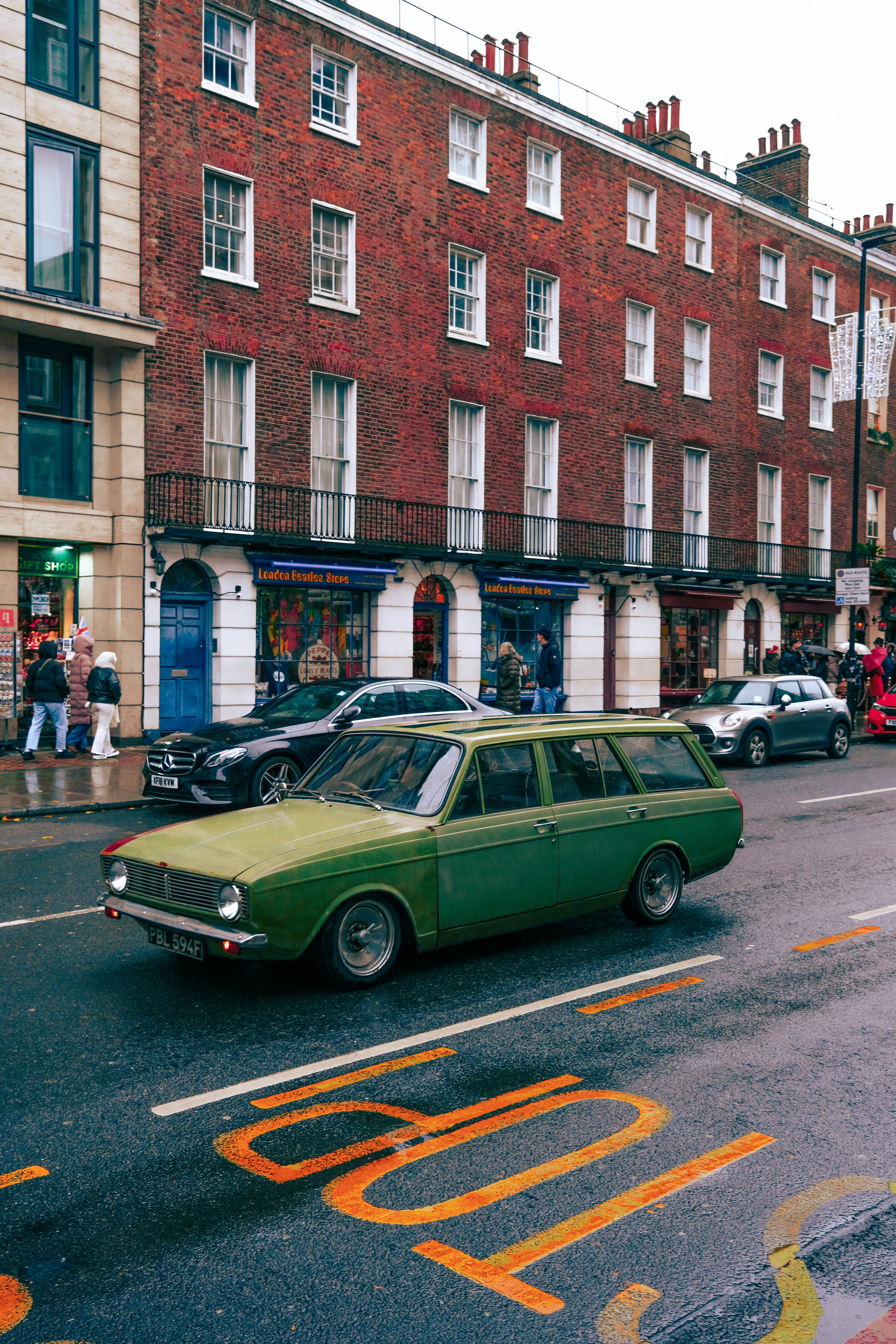 Green Classic on a London Street: A Vintage Car amid Brick Townhouses