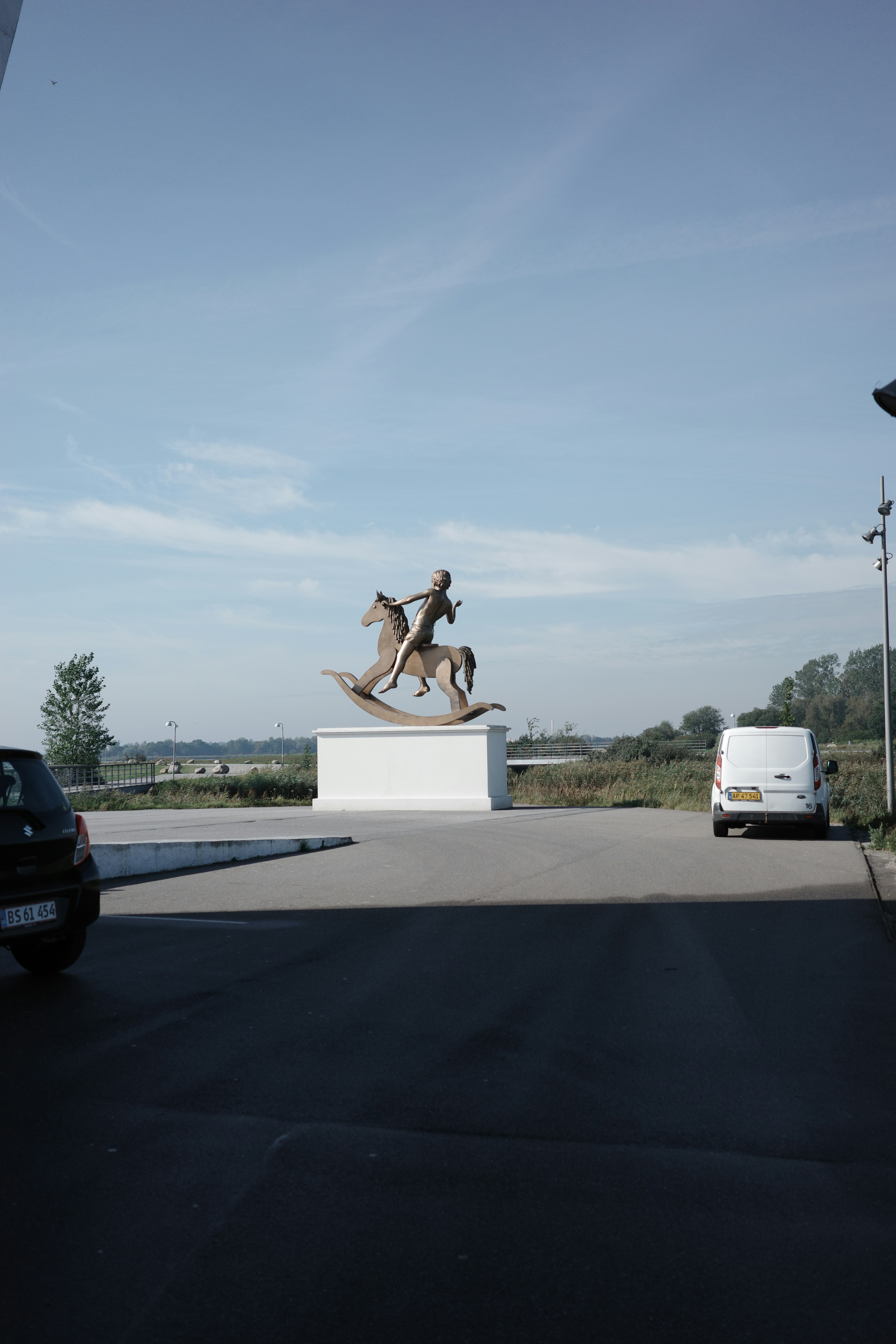 Bronze Equestrian Statue Anchored on a White Pedestal Under a Broad Blue Sky