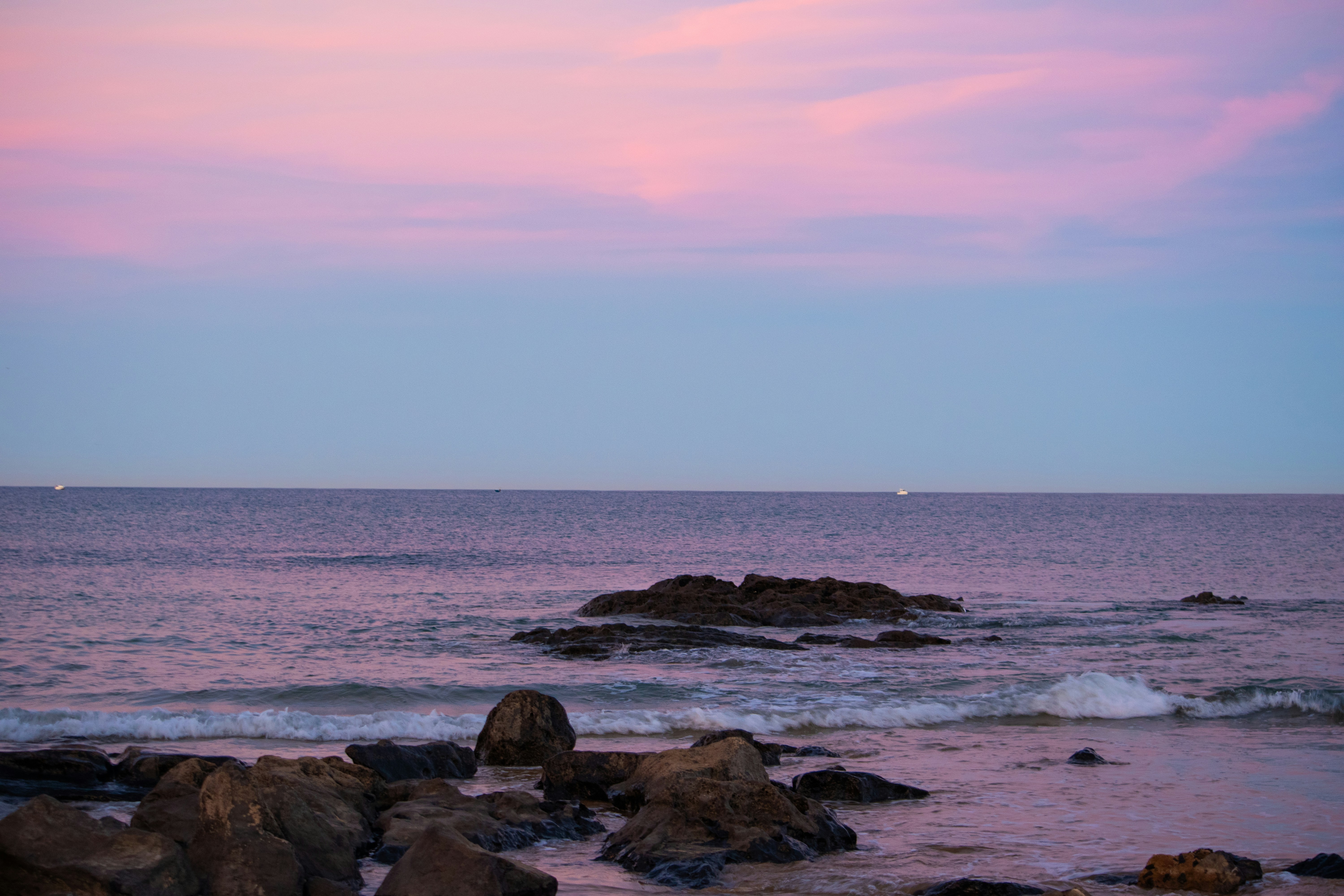 Rosy Dusk Over a Rocky Shoreline